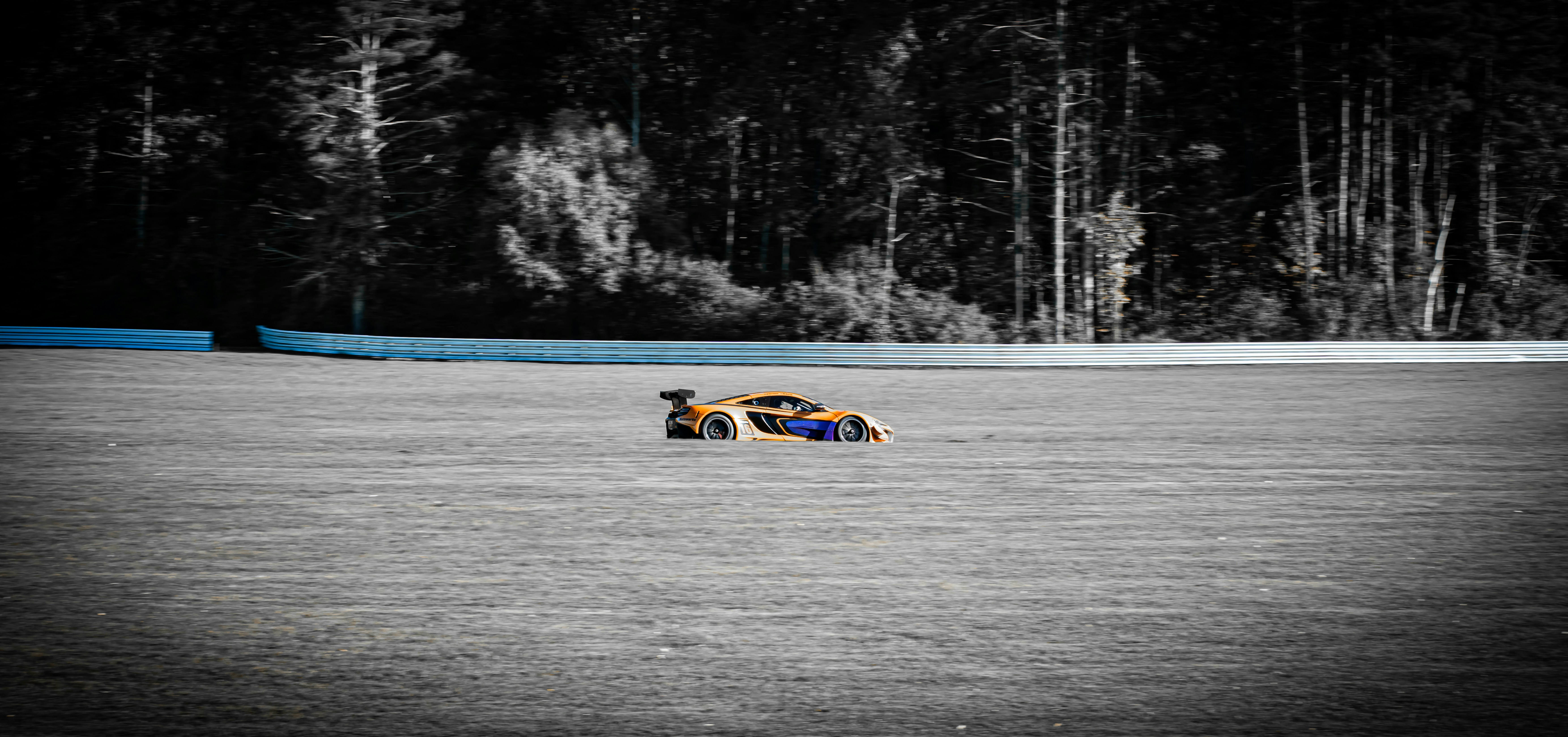 A yellow and blue race car on a frozen lake.