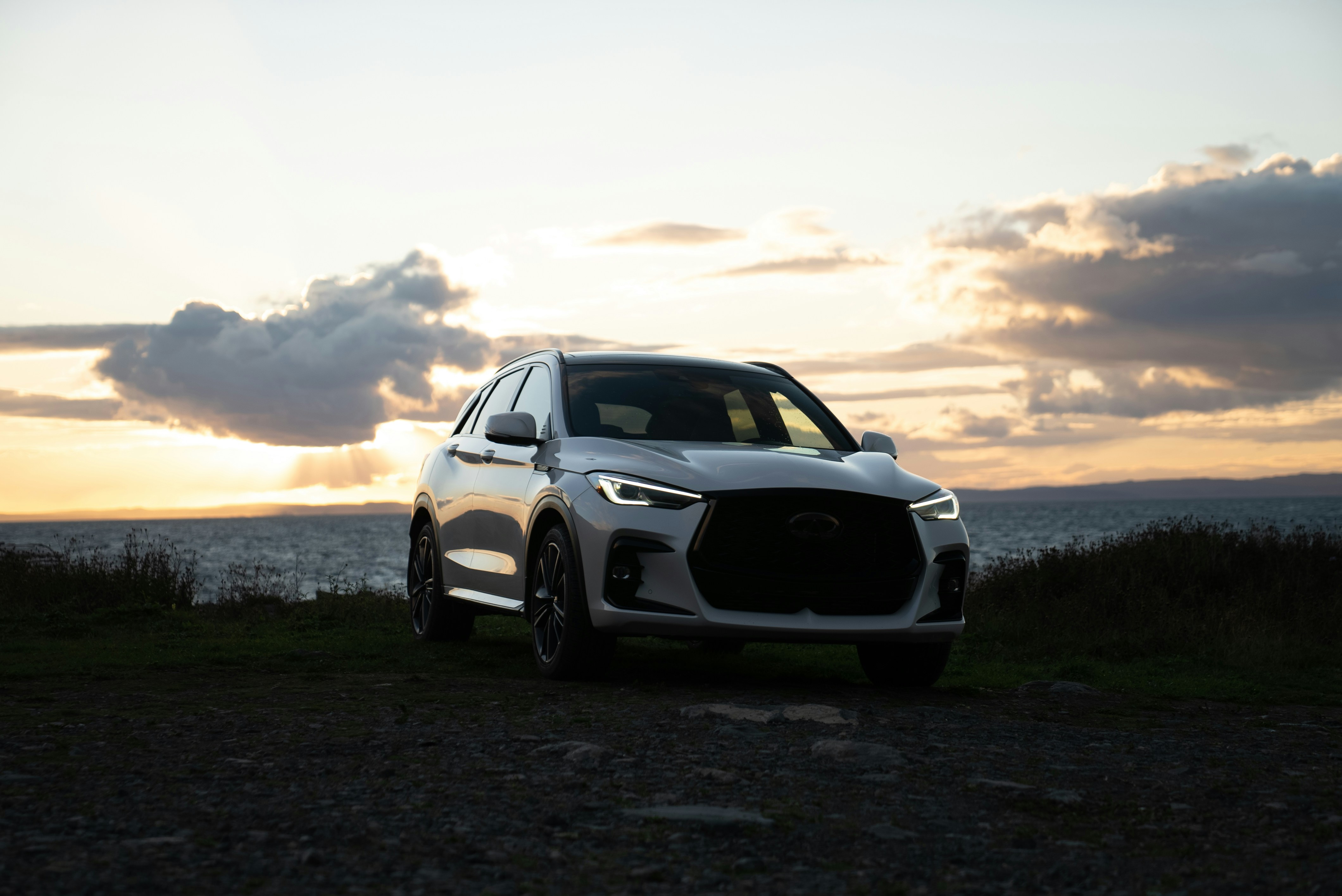 Coastal Sunset Standstill: A Silver SUV Anchored Against the Atlantic Horizon