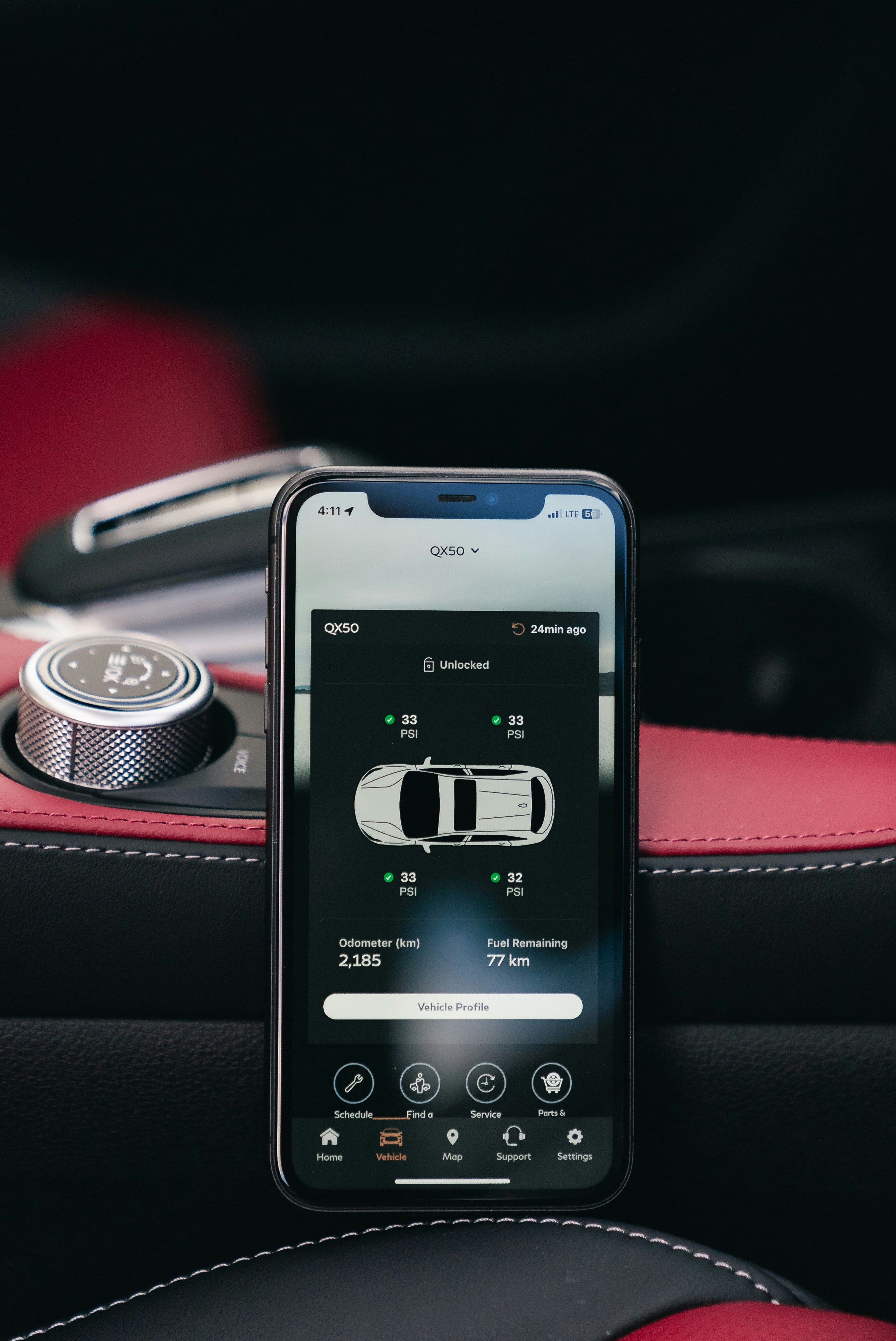 Smartphone displaying car diagnostics app on dashboard