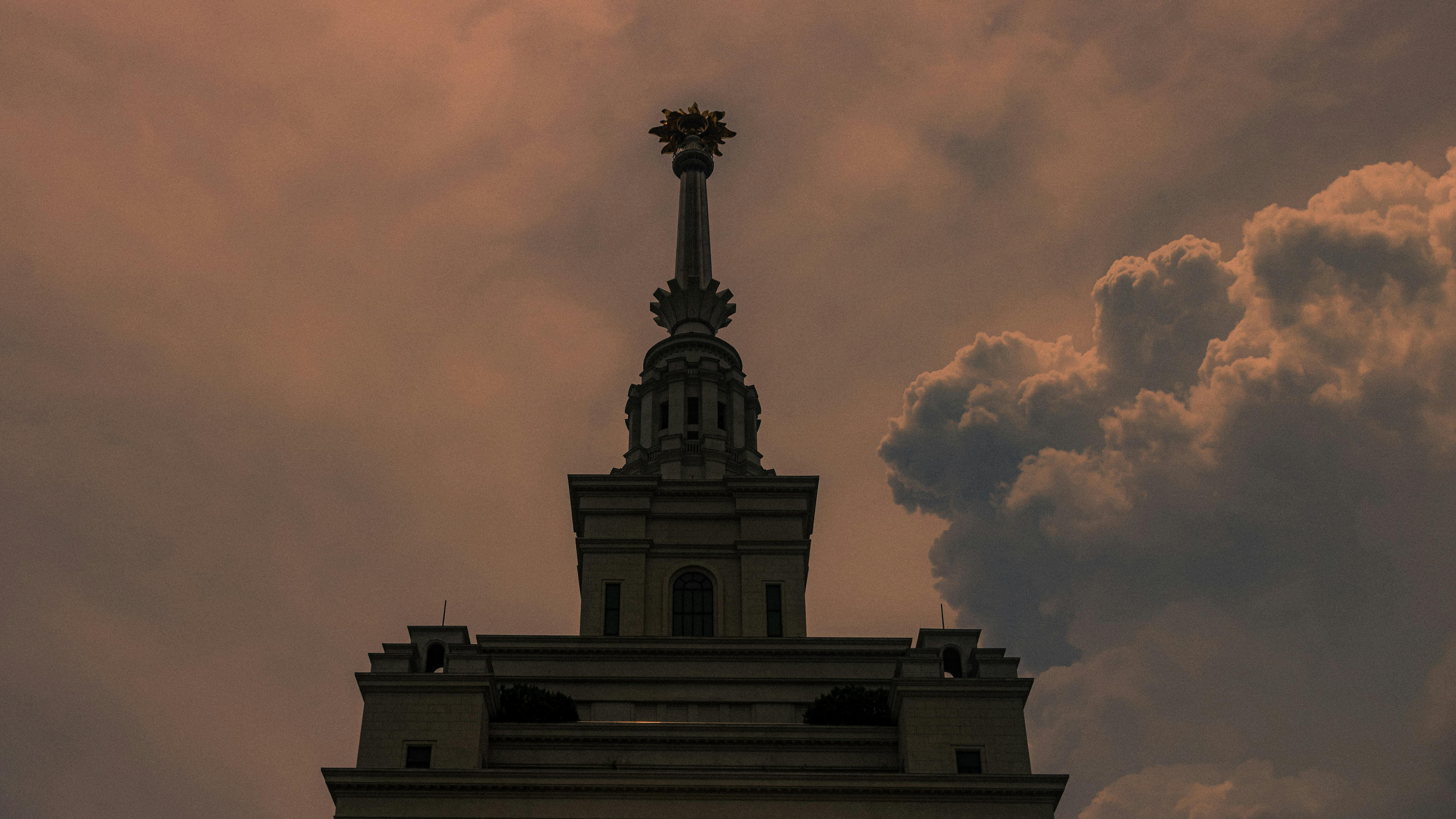 Ornate tower against a dramatic cloudy sky