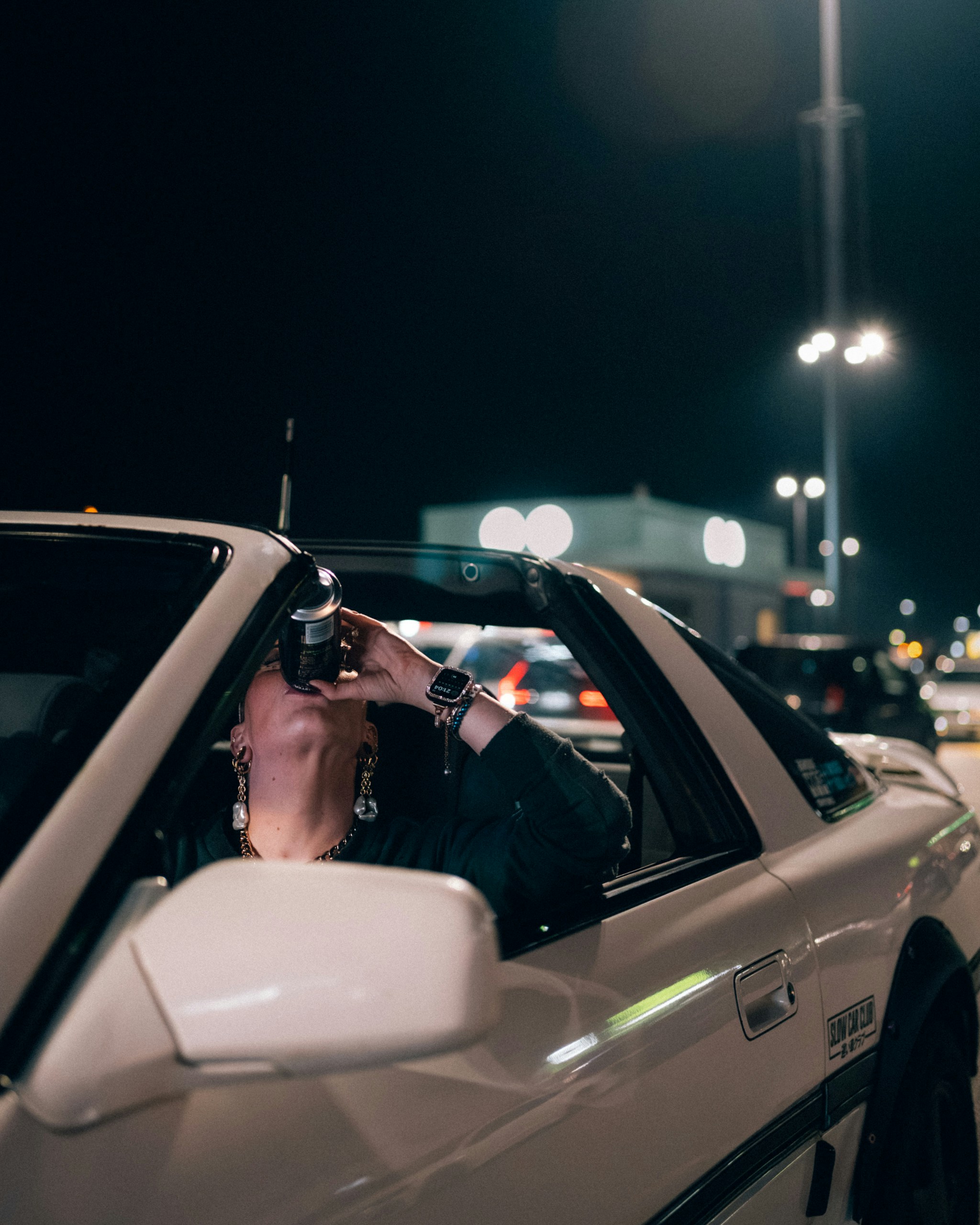 Victoria and her lovely Mk3 Supra at KKB - kungenskurvabilträff | Person drinks from can inside car at night