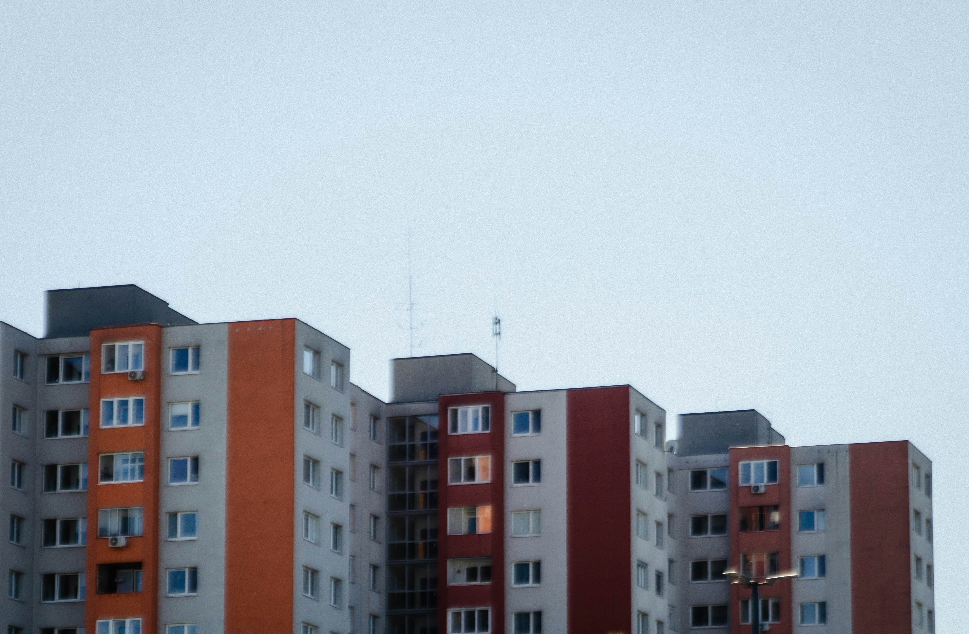 Apartment buildings with orange and gray facades.