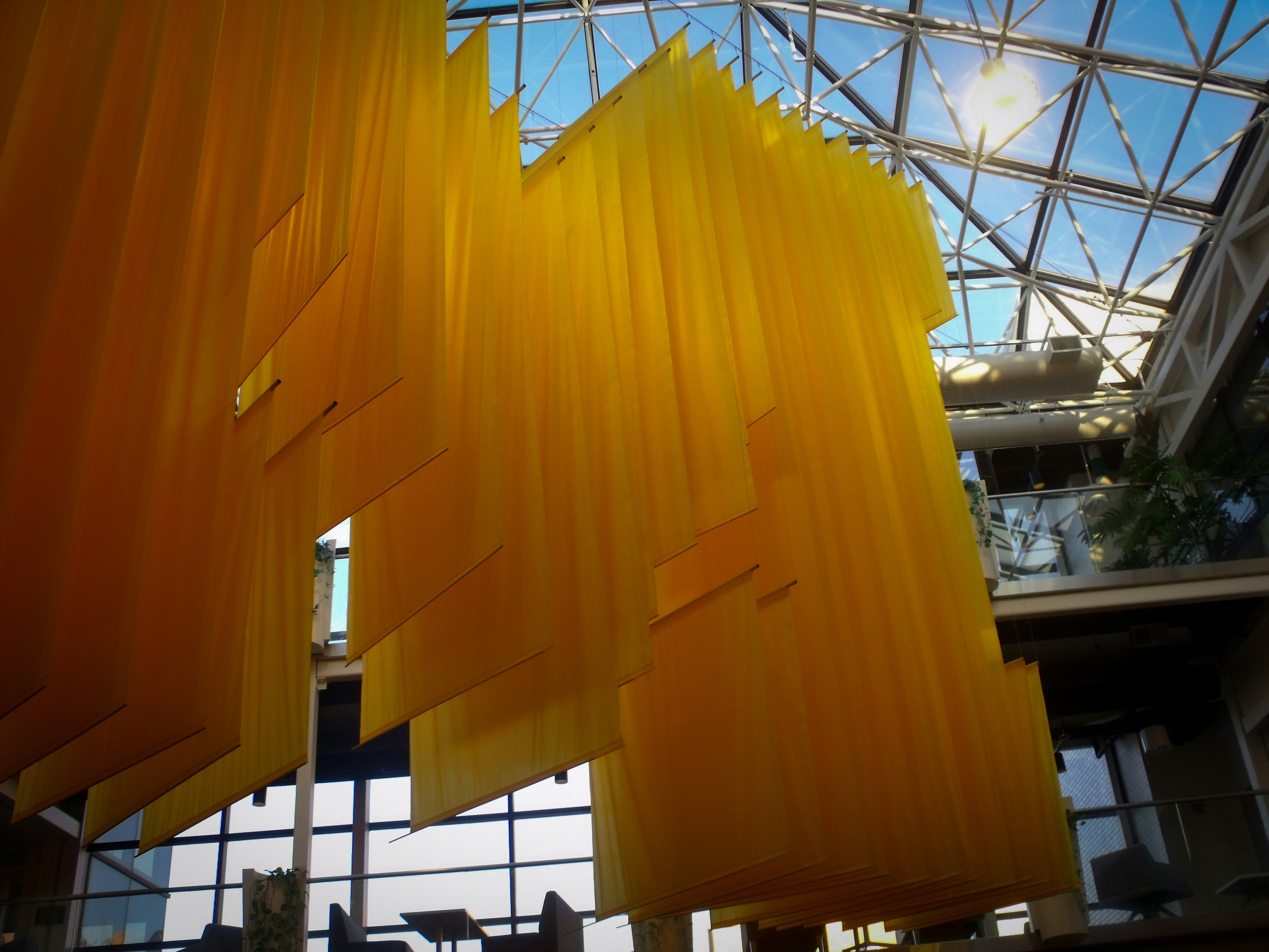 Yellow fabric installation hangs from ceiling