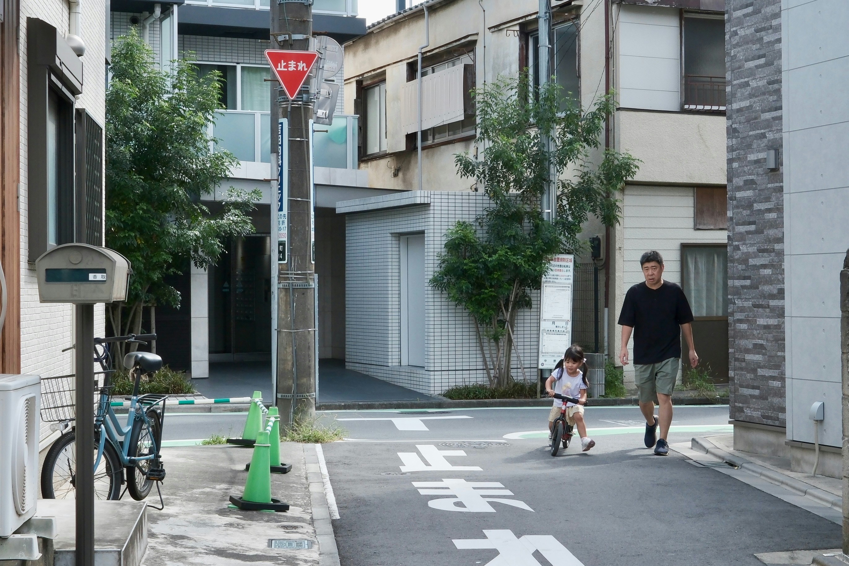 Tiny Cyclist in a Quiet City Street