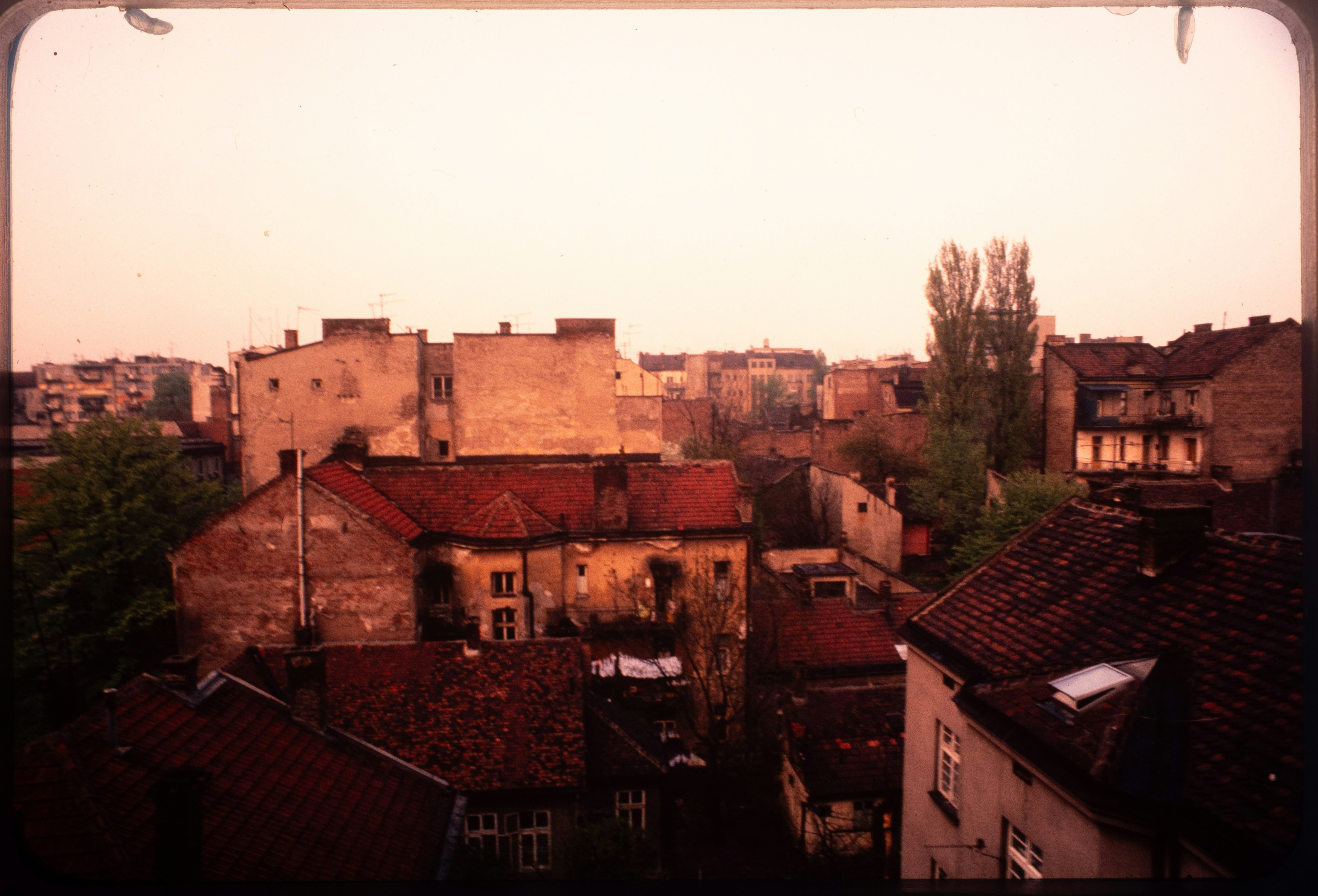 OLYMPUS DIGITAL CAMERA | Overhead view of aged european city buildings.