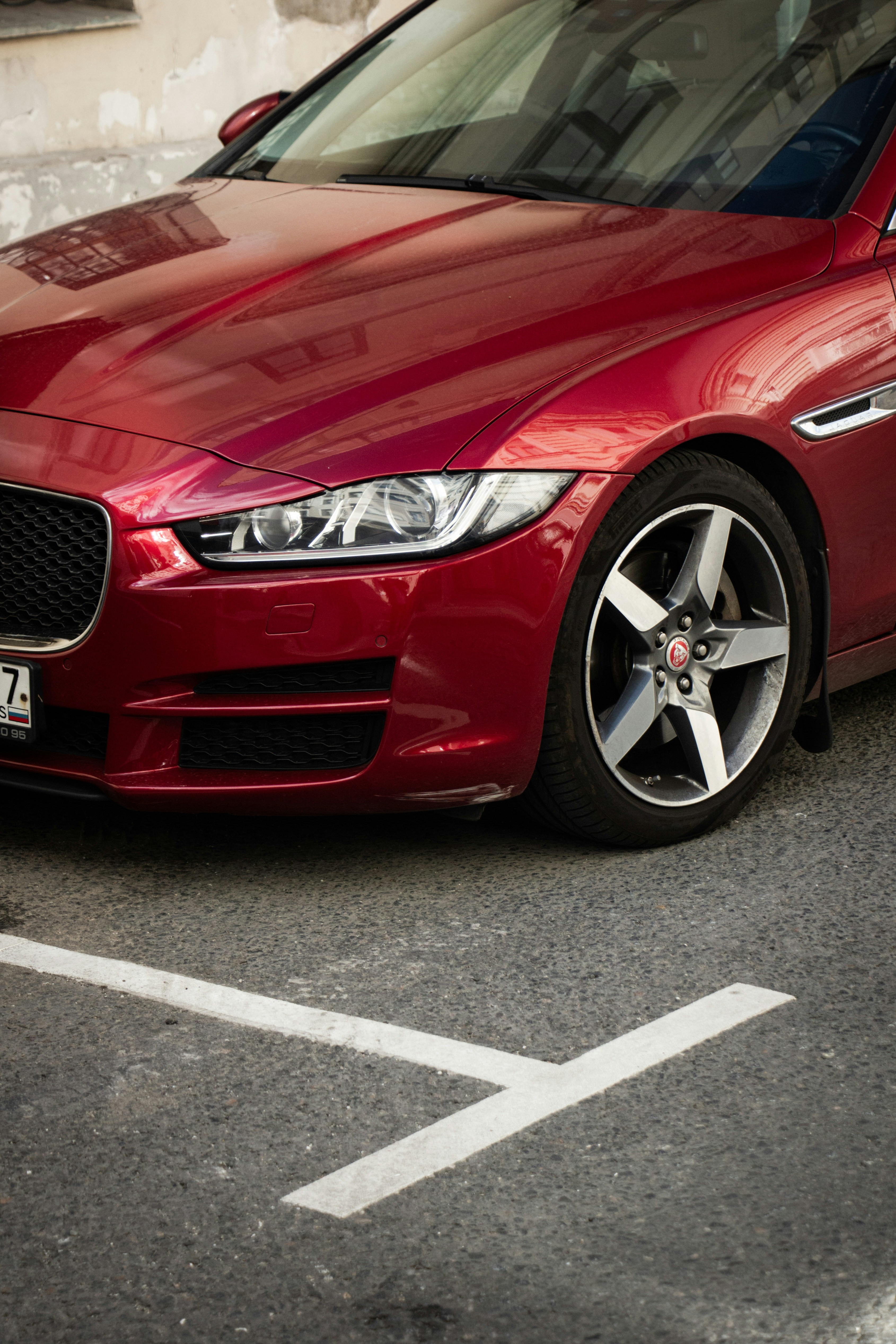 Jaguar XE | A close-up of a red luxury car parked.