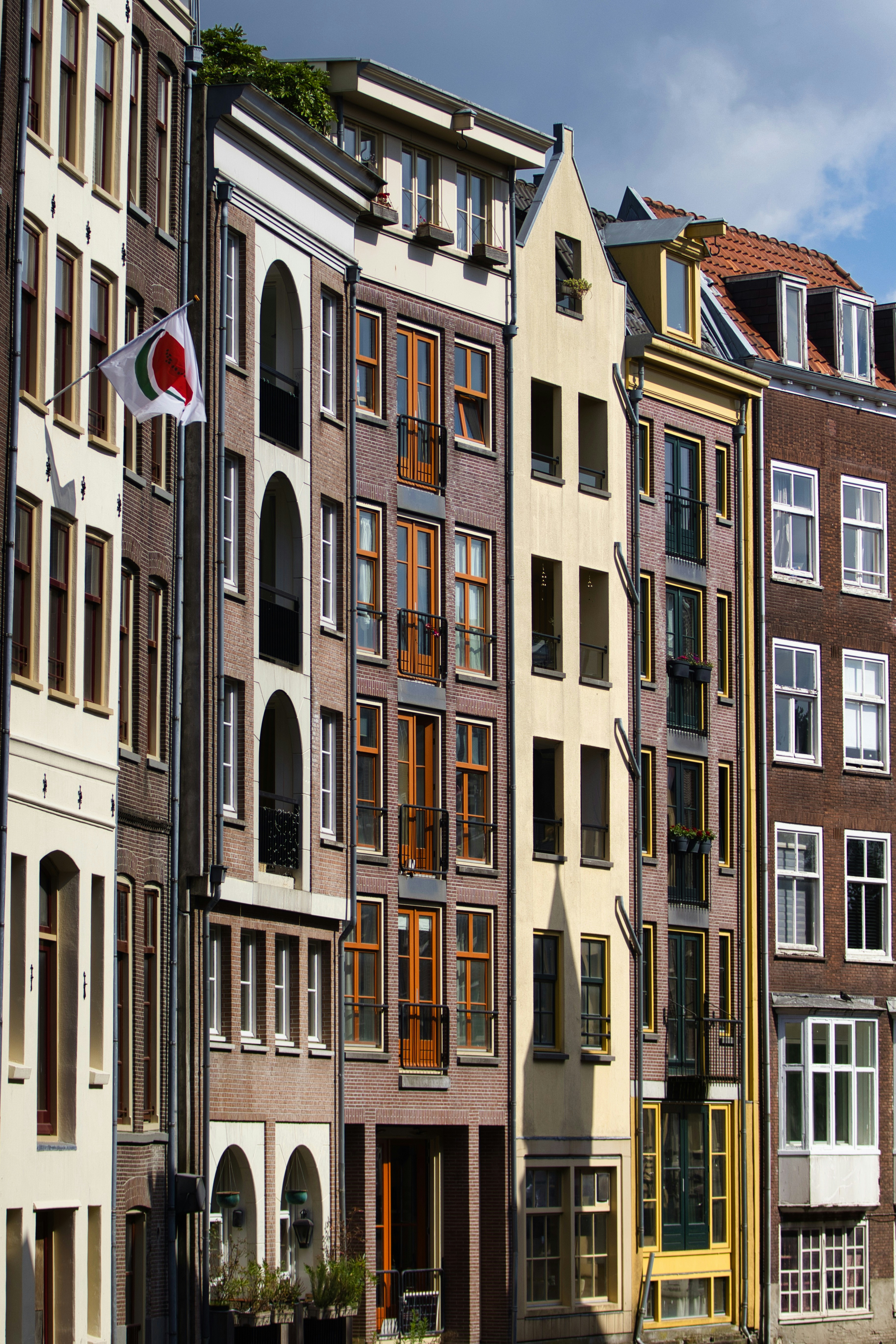 Colorful buildings with distinct architectural styles lining a canal, showcasing urban design and cultural heritage.