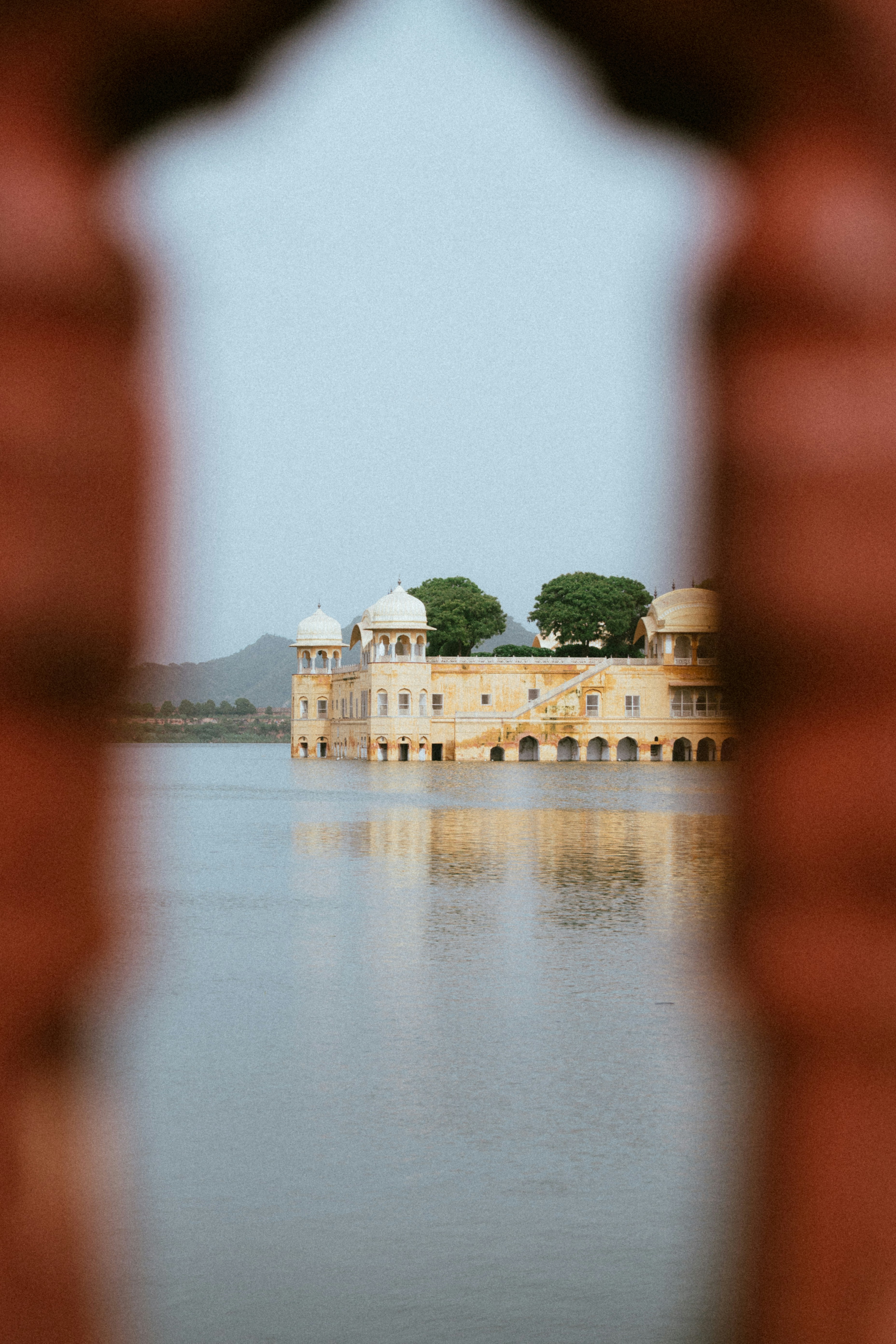 Palace partially submerged in water with arched foreground