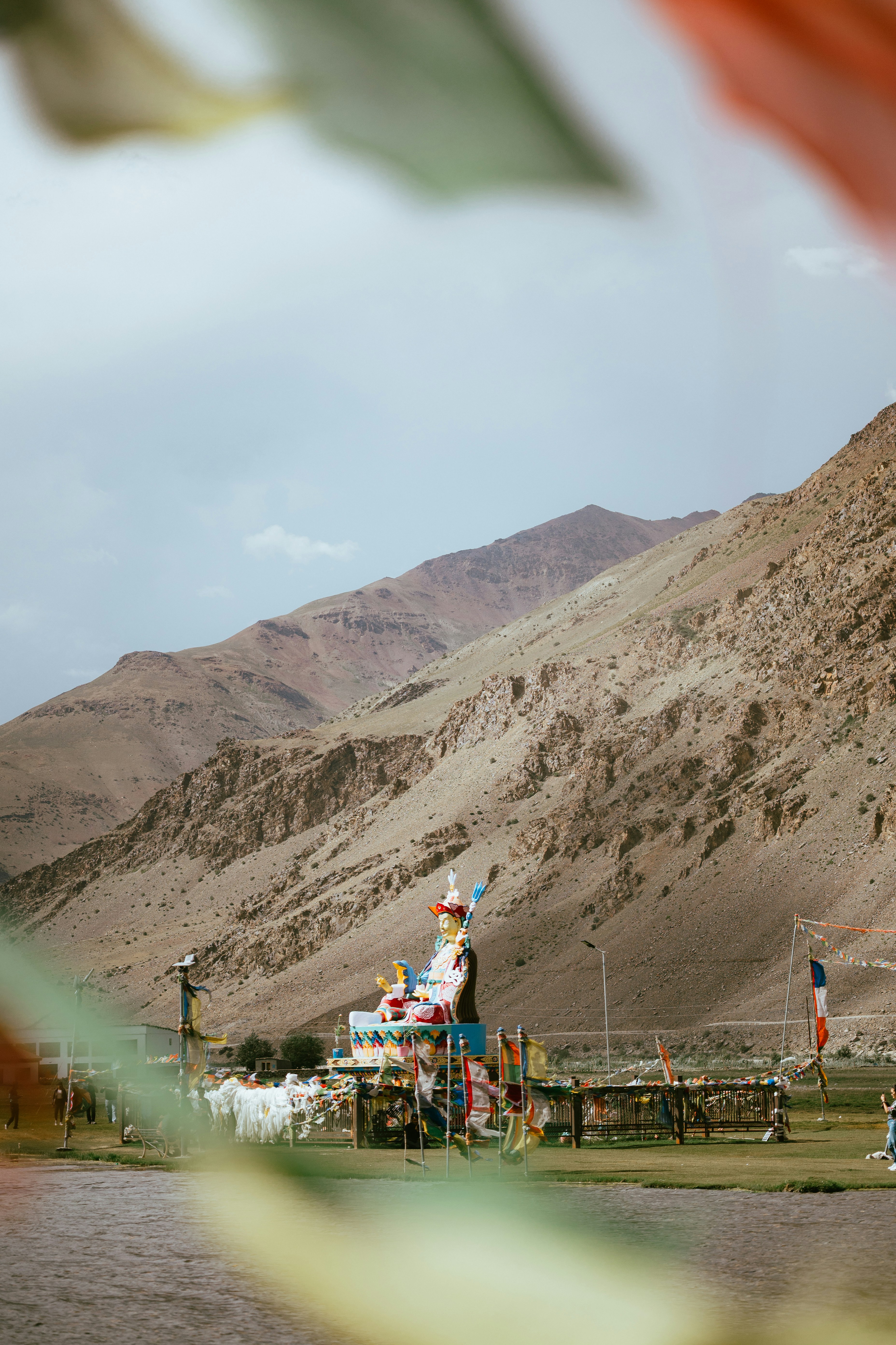 Buddhist stupa with prayer flags and mountains