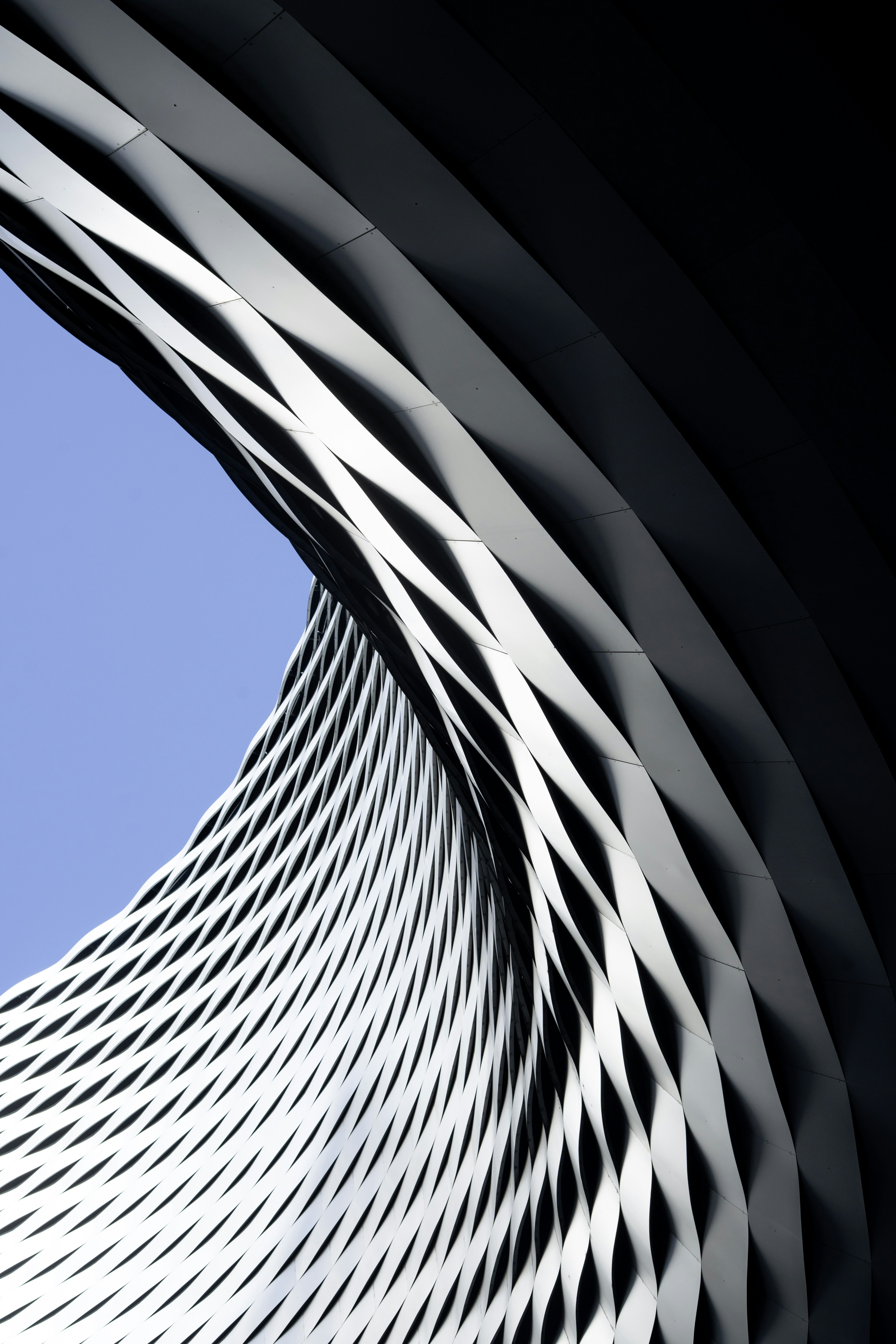 Modern architectural structure with geometric patterns against sky