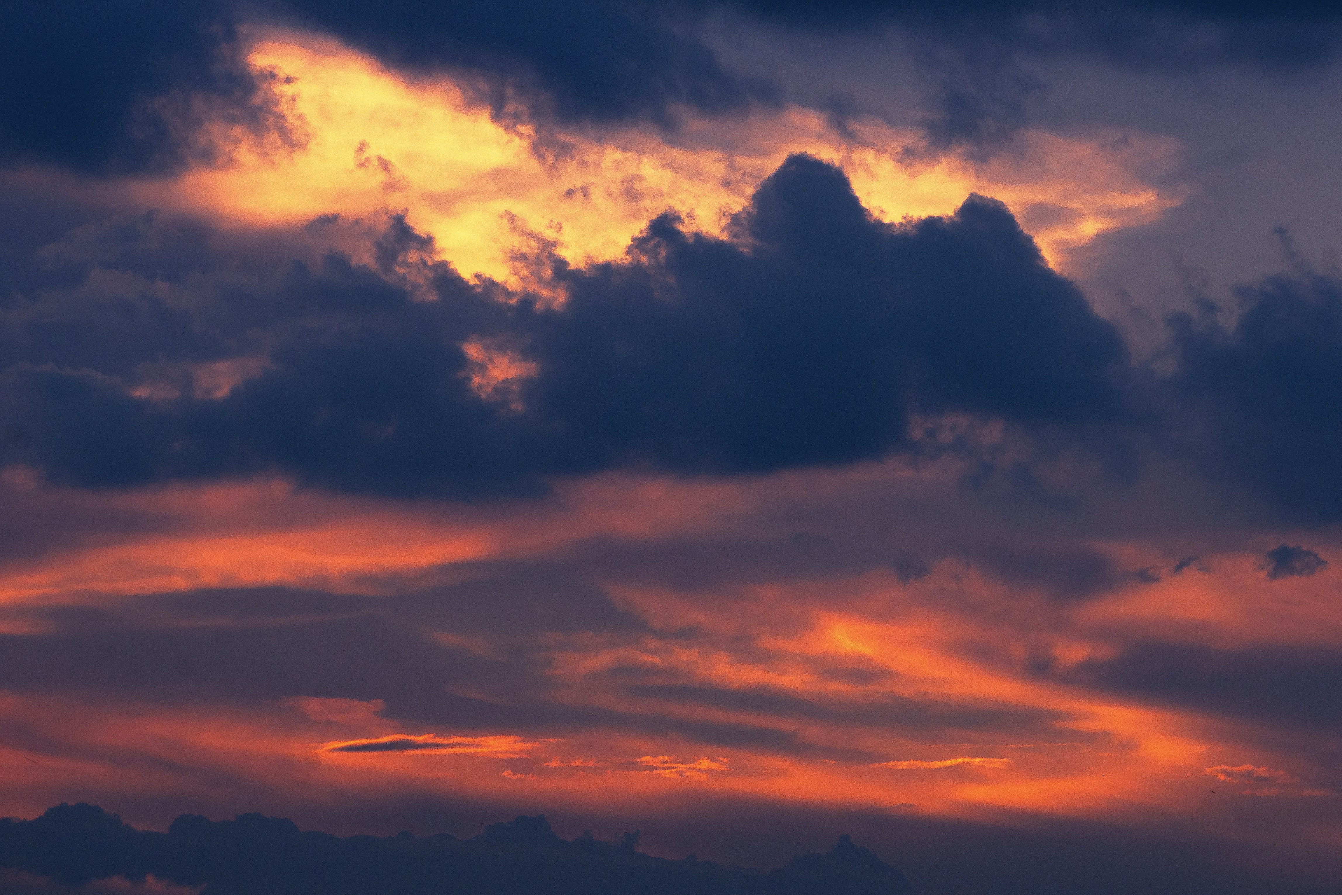Dramatic sunset clouds with vibrant orange and purple hues.
