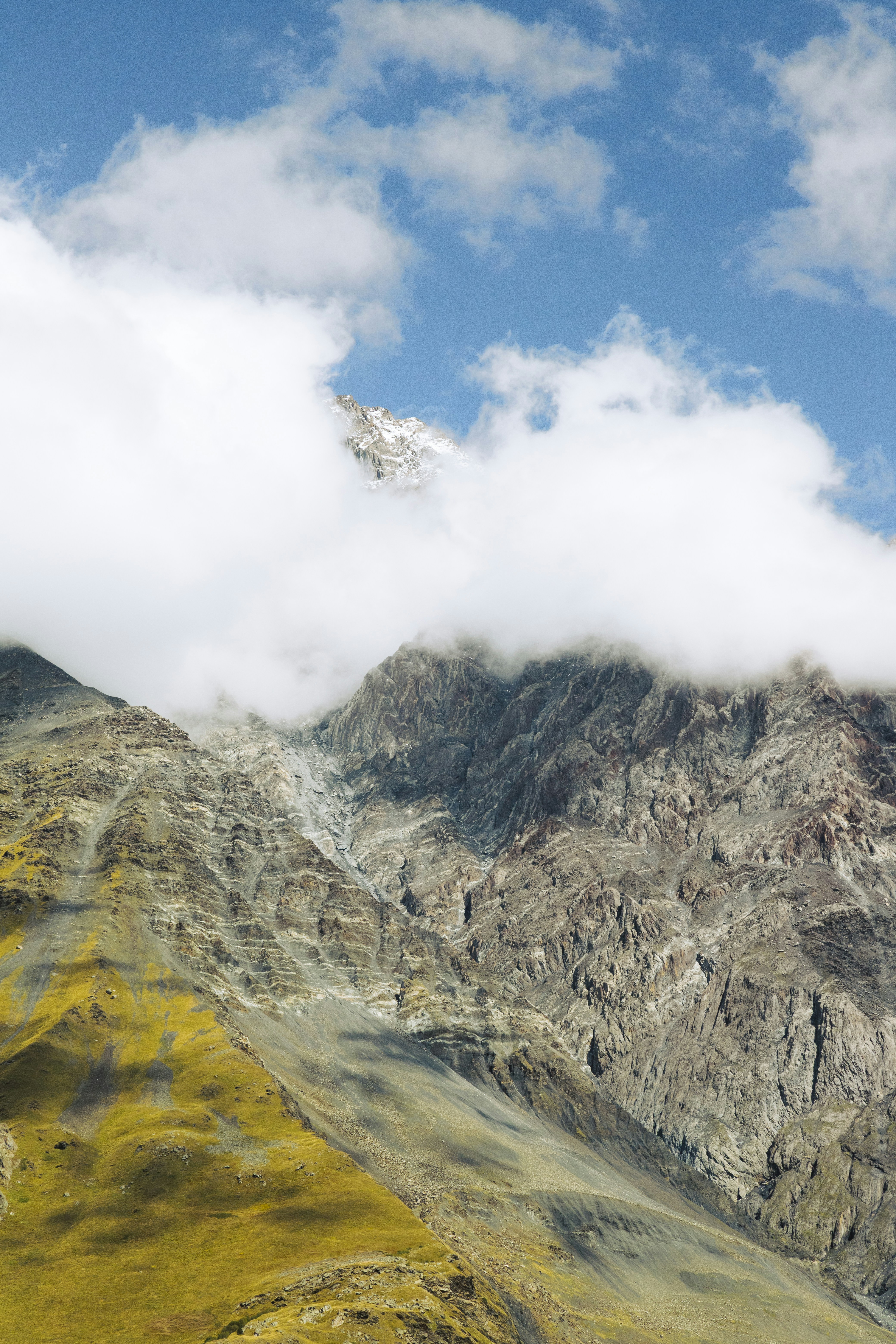 Veil of Clouds Over Majestic Peaks