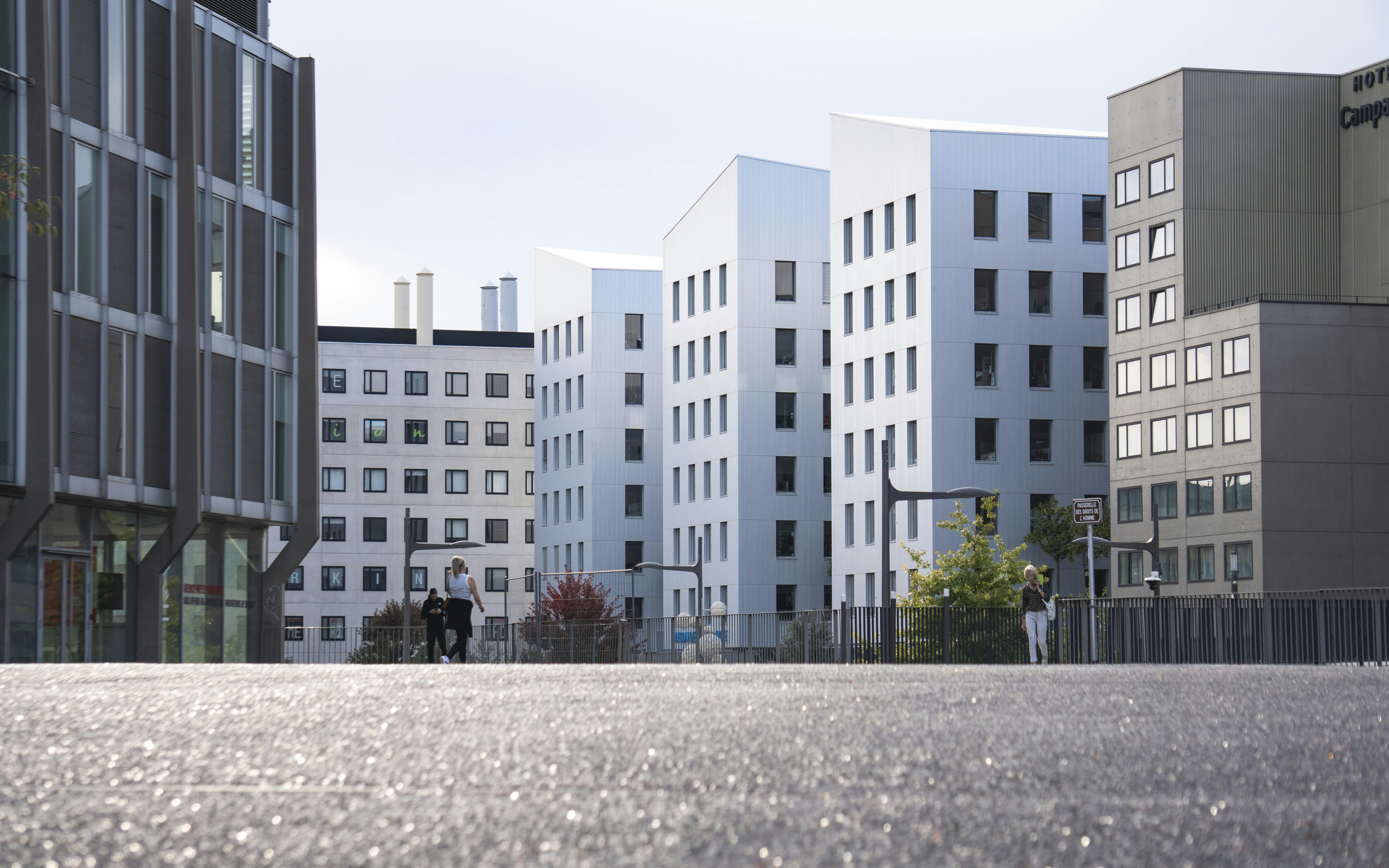 Quartier de l'amphithéâtre de Metz, Moselle (France | Modern white buildings with geometric designs against sky.