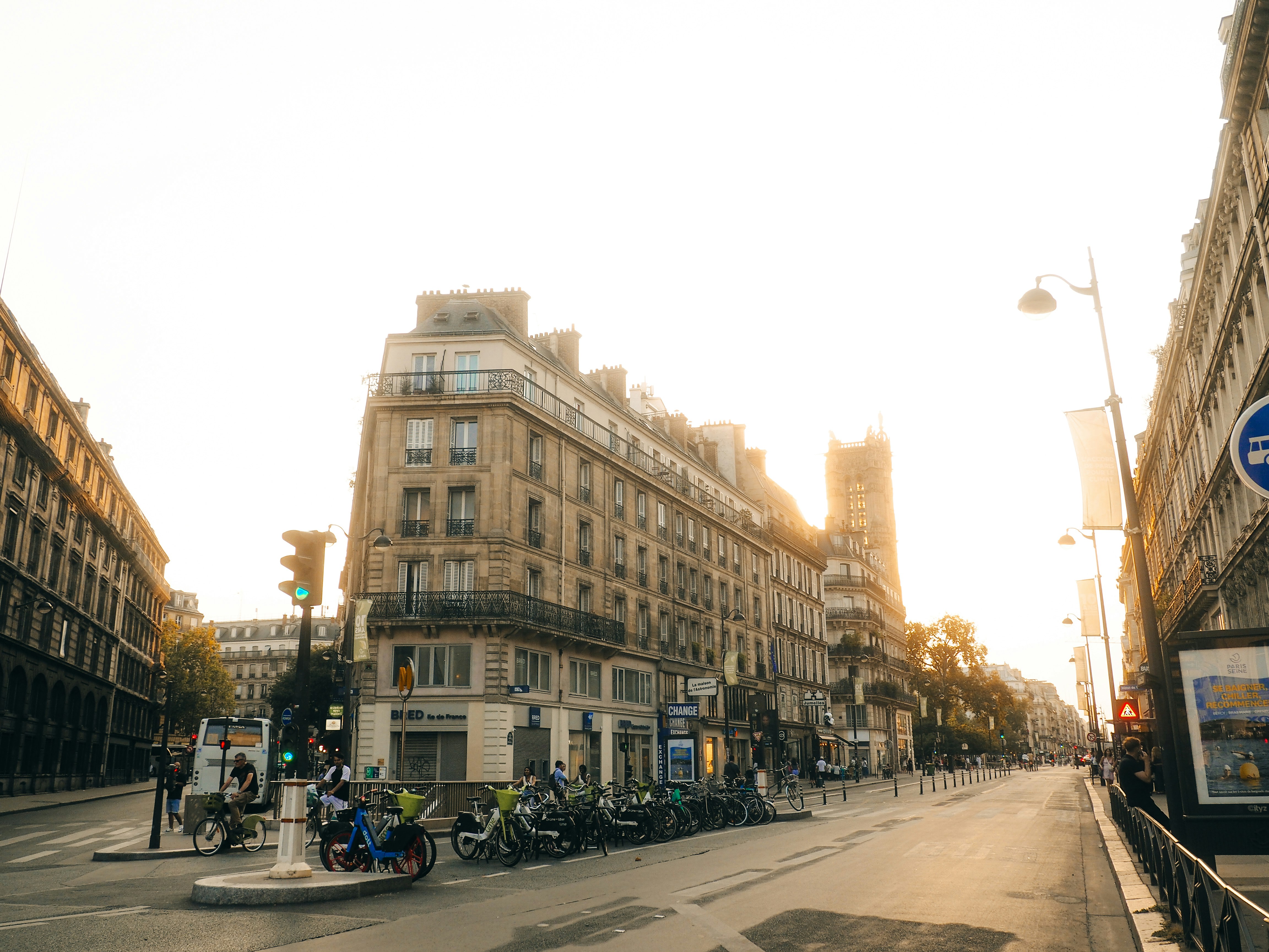 In Paris at night, the Eiffel Tower shines like a lighthouse for lovers. This image blends romantic photography, honeymoon vibes, and timeless travel inspiration. A couple sits together, holding close, while the tower sparkles above the Seine, symbolizing romance, intimacy, affection, passion, desire, and connection. It’s about romantic tourism, love stories, relationship goals, and Parisian nights. The glowing iron giant becomes more than architecture—it transforms into a backdrop for wedding dreams, engagement shoots, anniversary trips, and honeymoon escapes. With every golden sparkle, this | Street in paris with buildings and sunlight