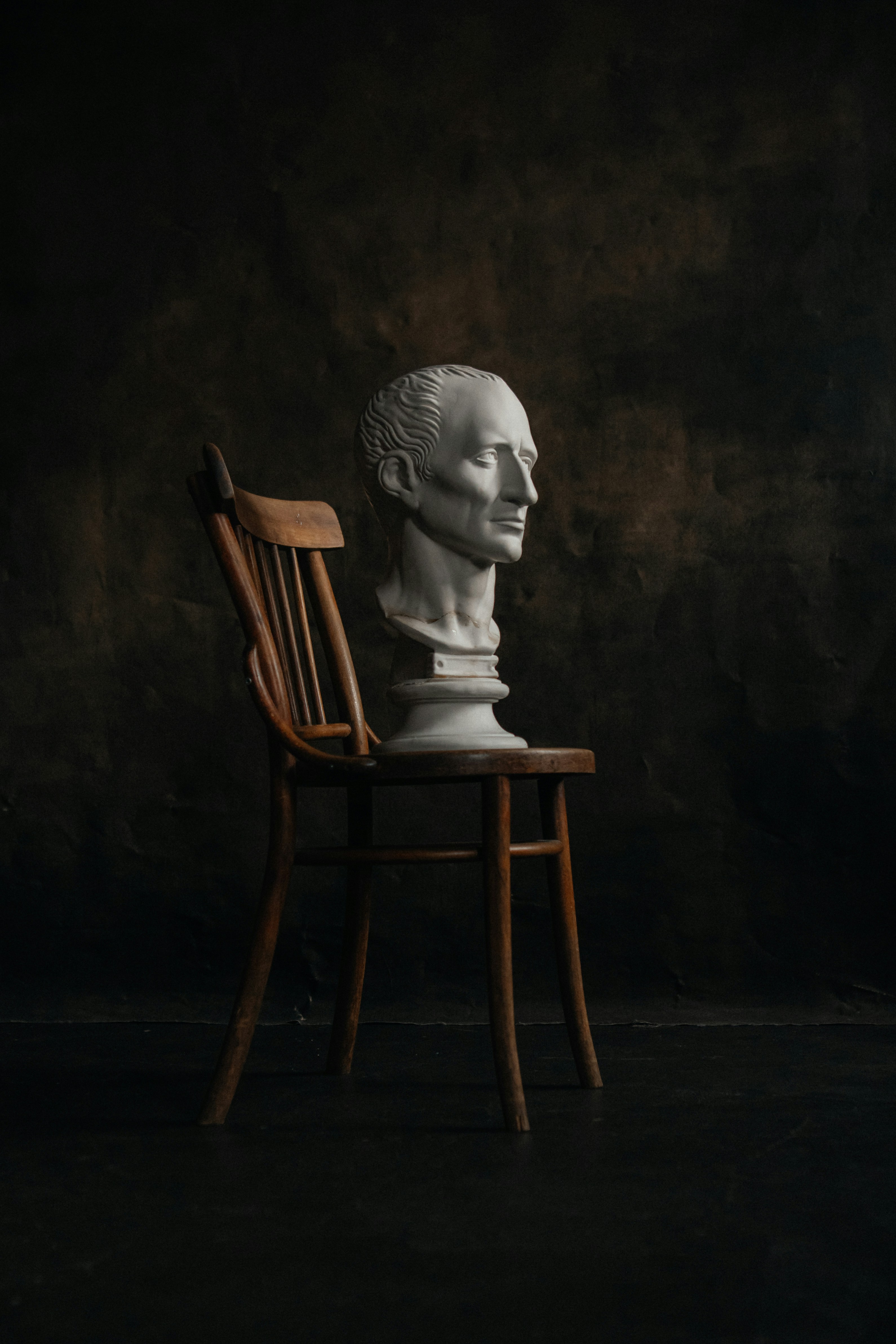 Silent Muse on a Weathered Chair