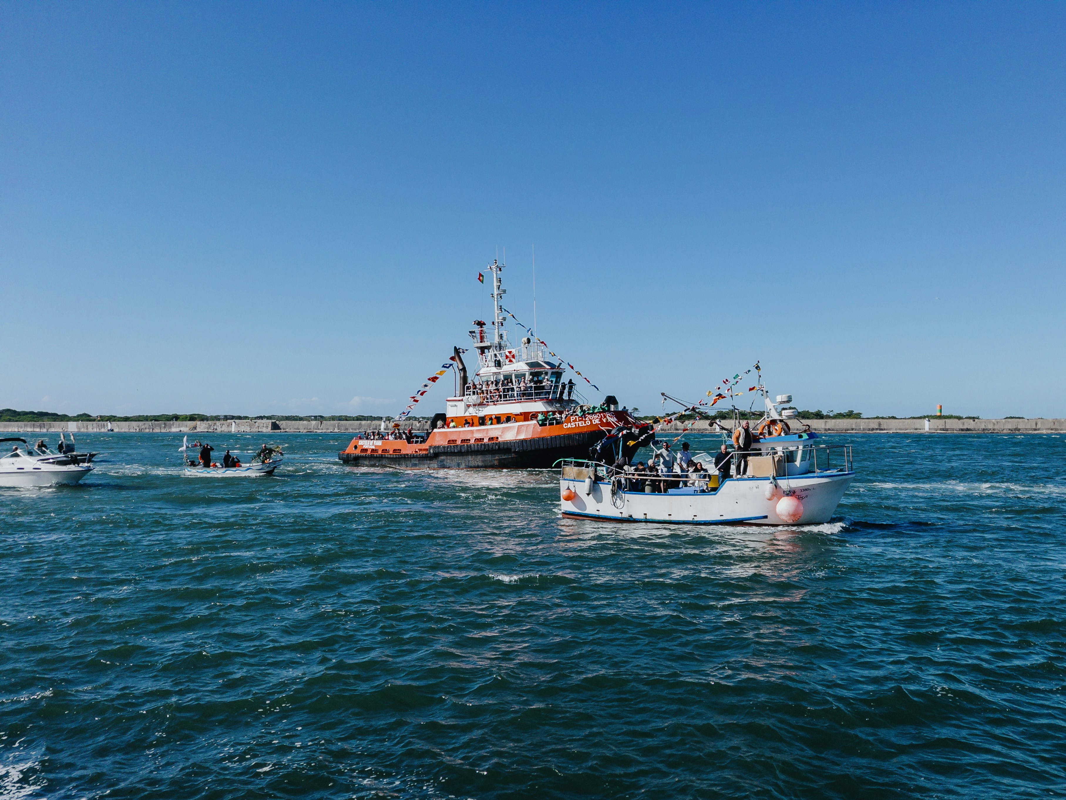 Tugboat and boats sailing on the water