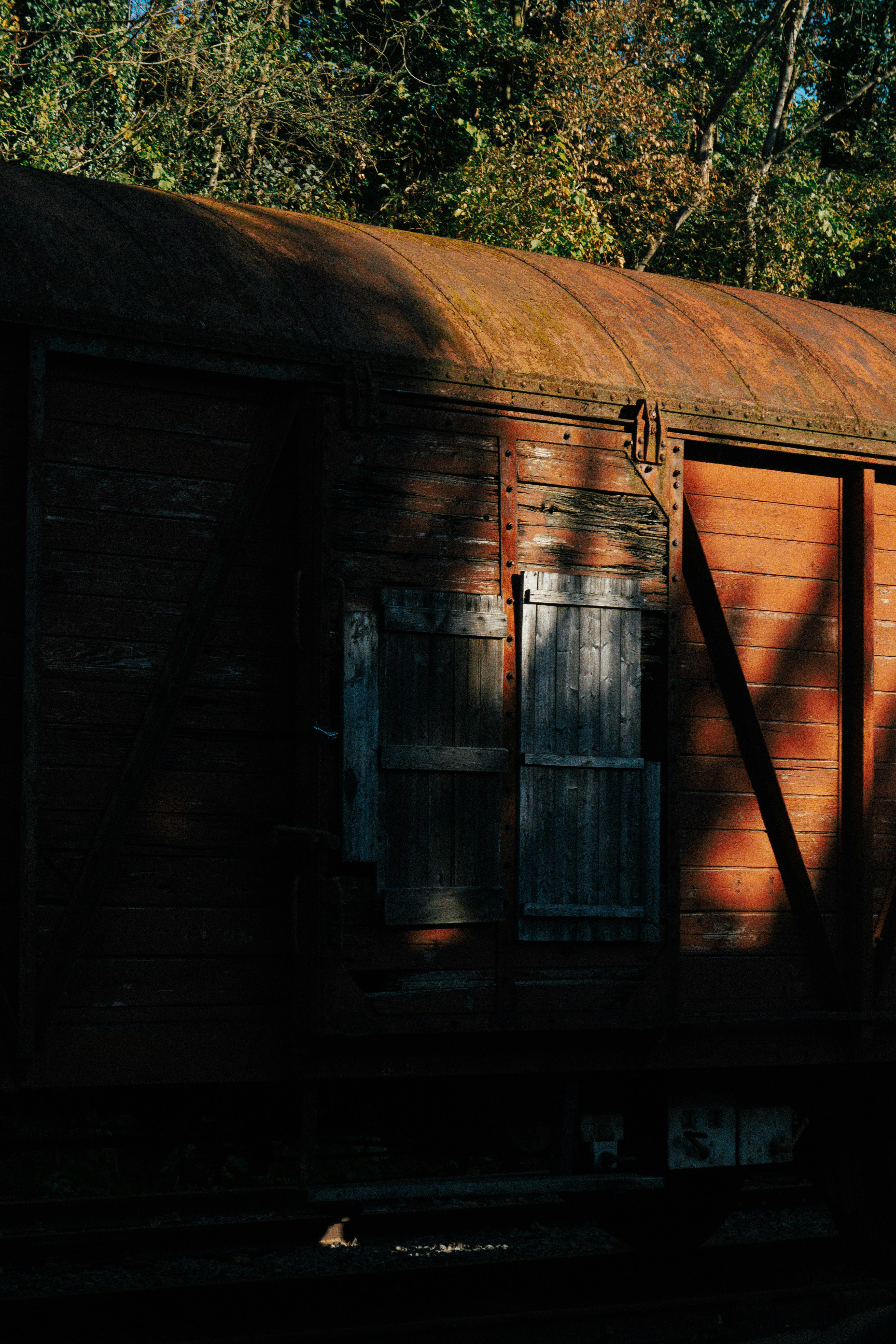 Rustic wooden train car with closed shutters.