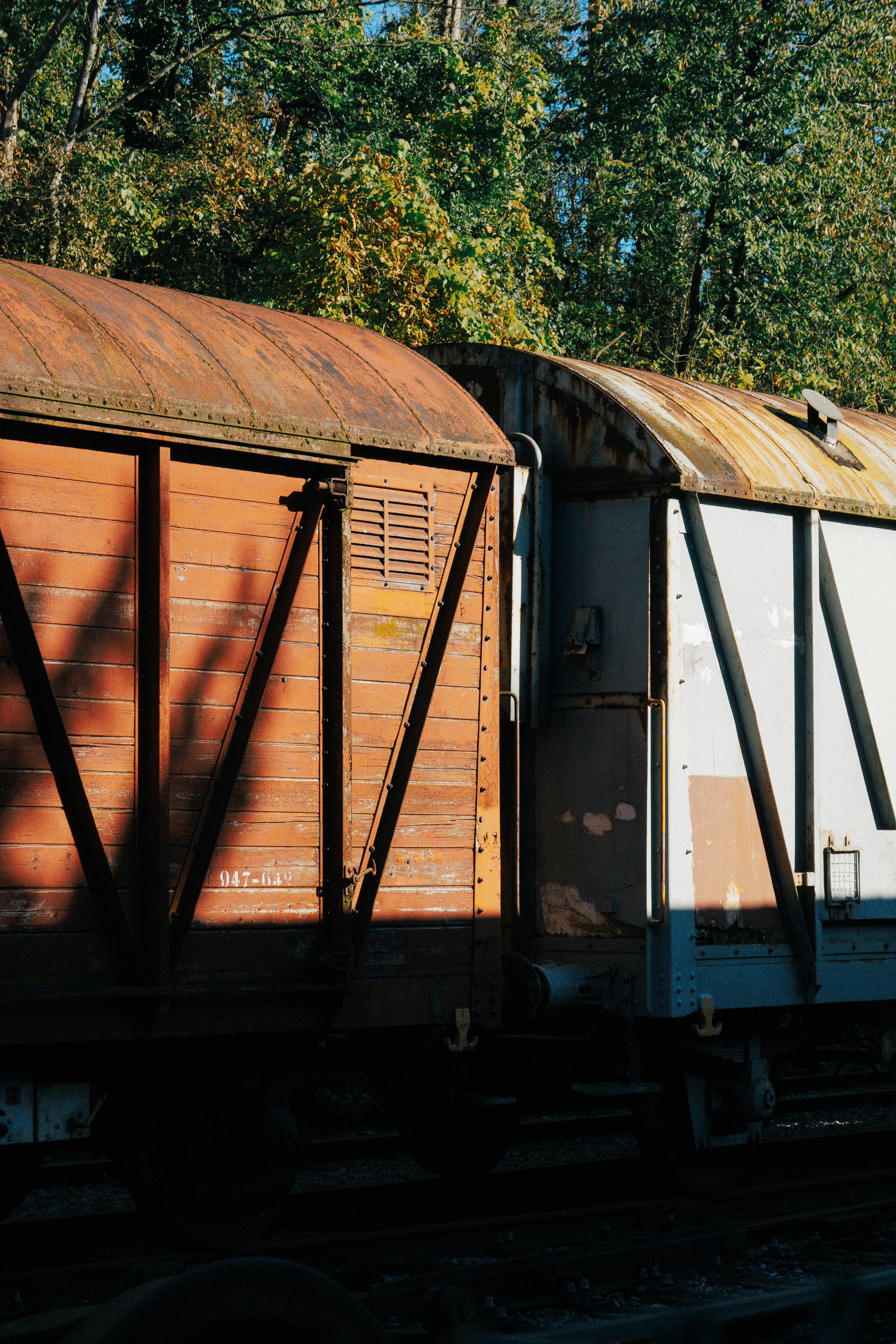 Two old train cars with rusty details.