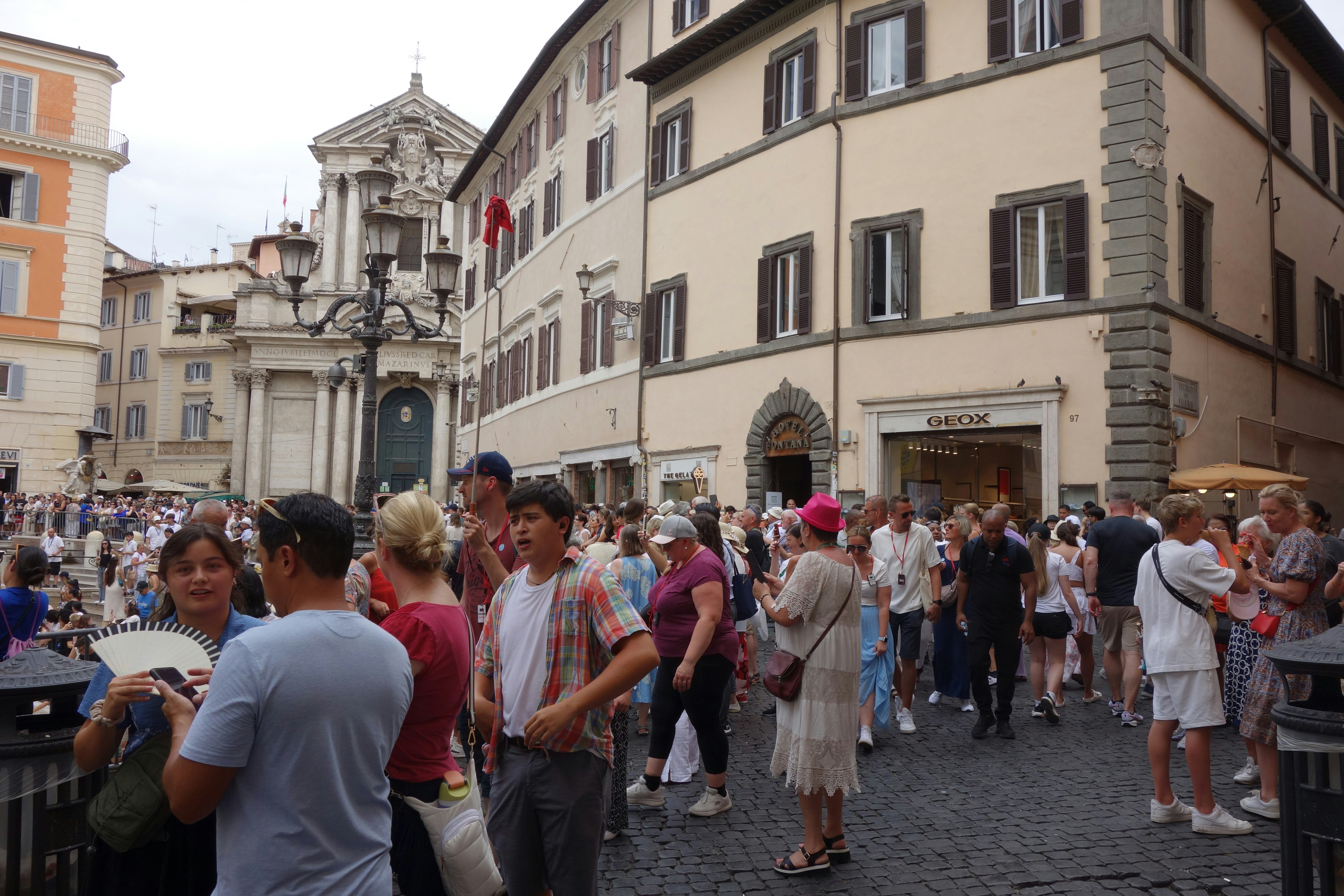 Sunlit Piazza Pulse: A Crowd Among Old-World Facades