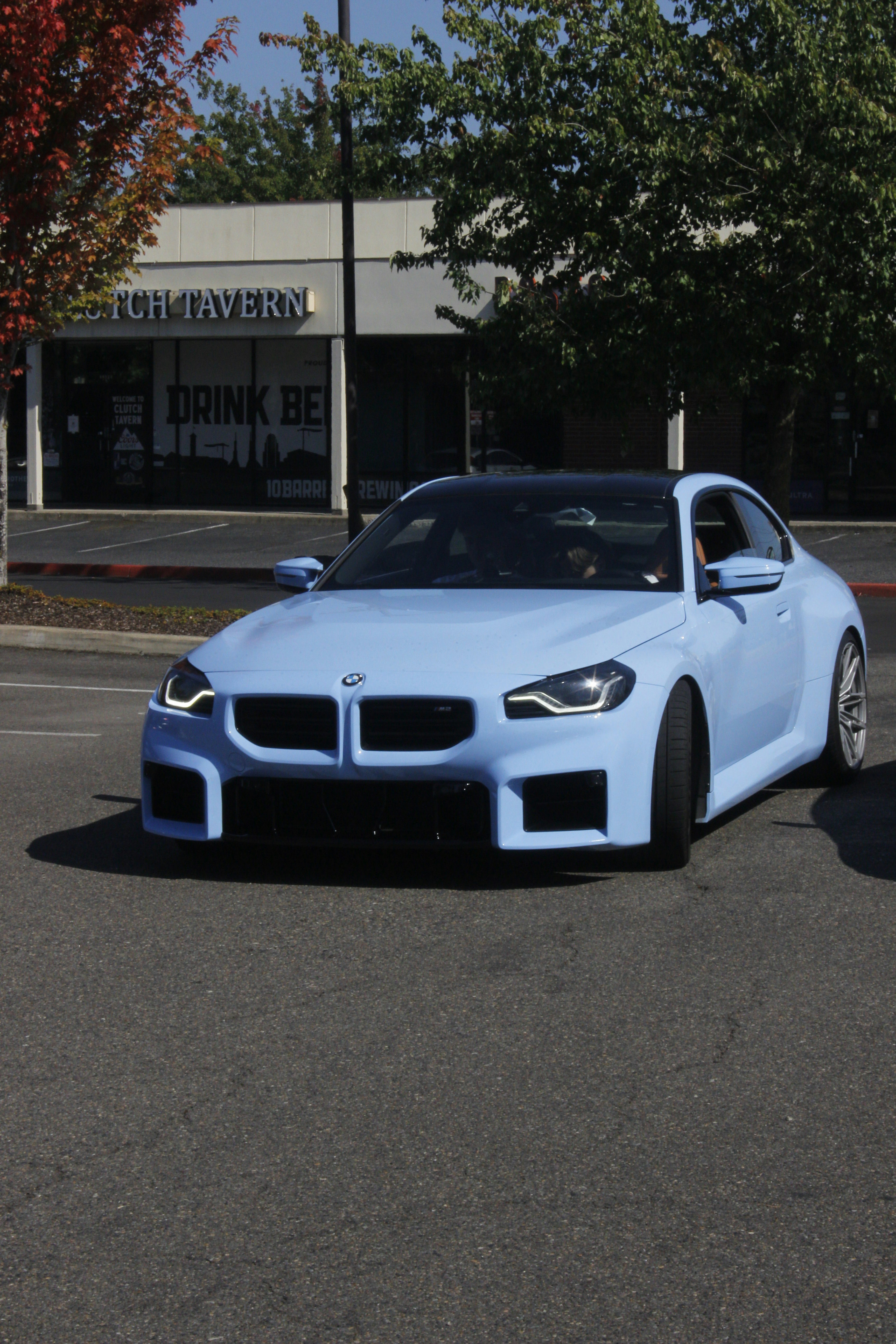 Minted Neon: A Bluish BMW Dominates the Parking Lot