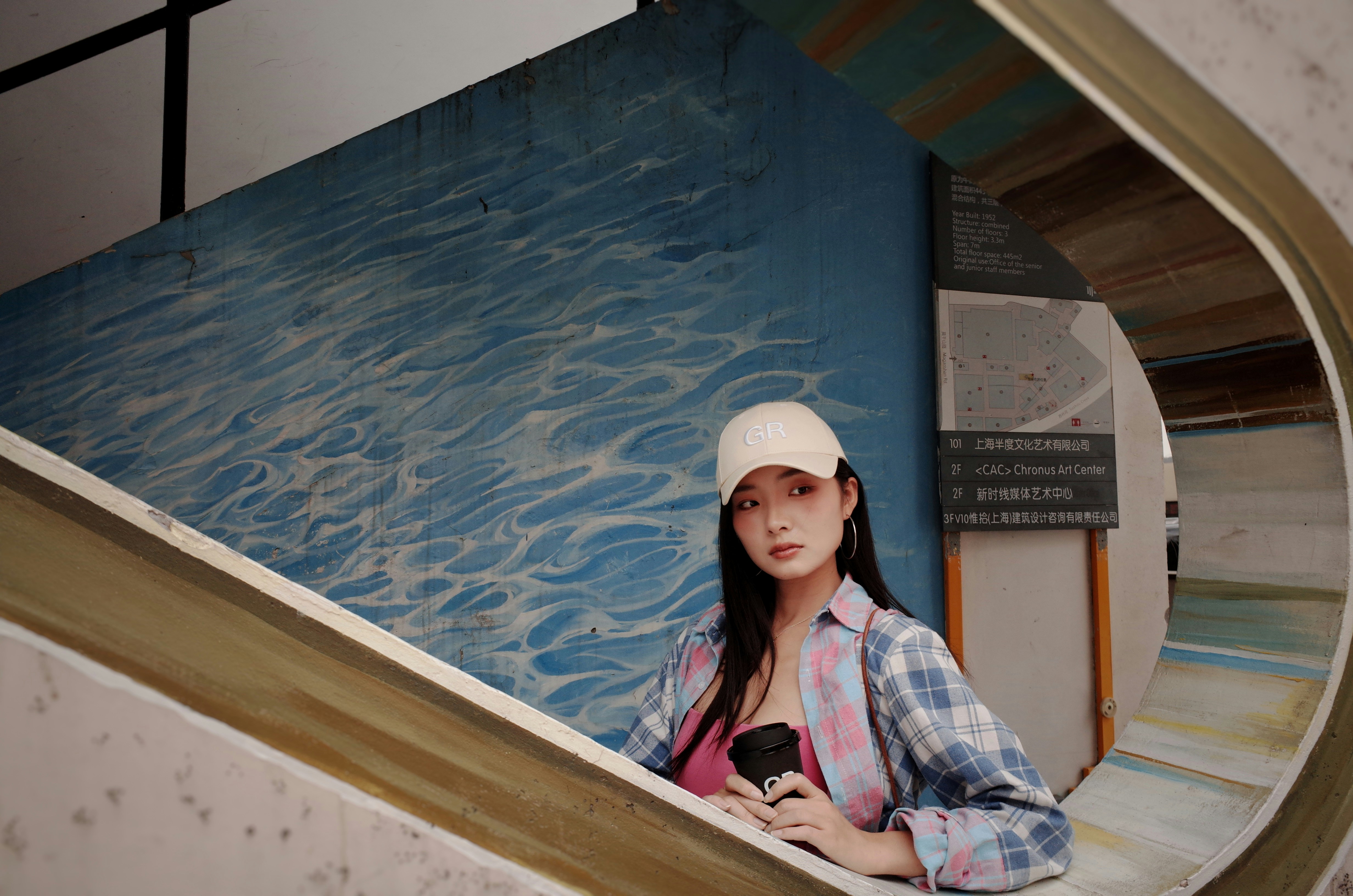 Young woman in baseball cap and plaid shirt indoors photo – Free ...