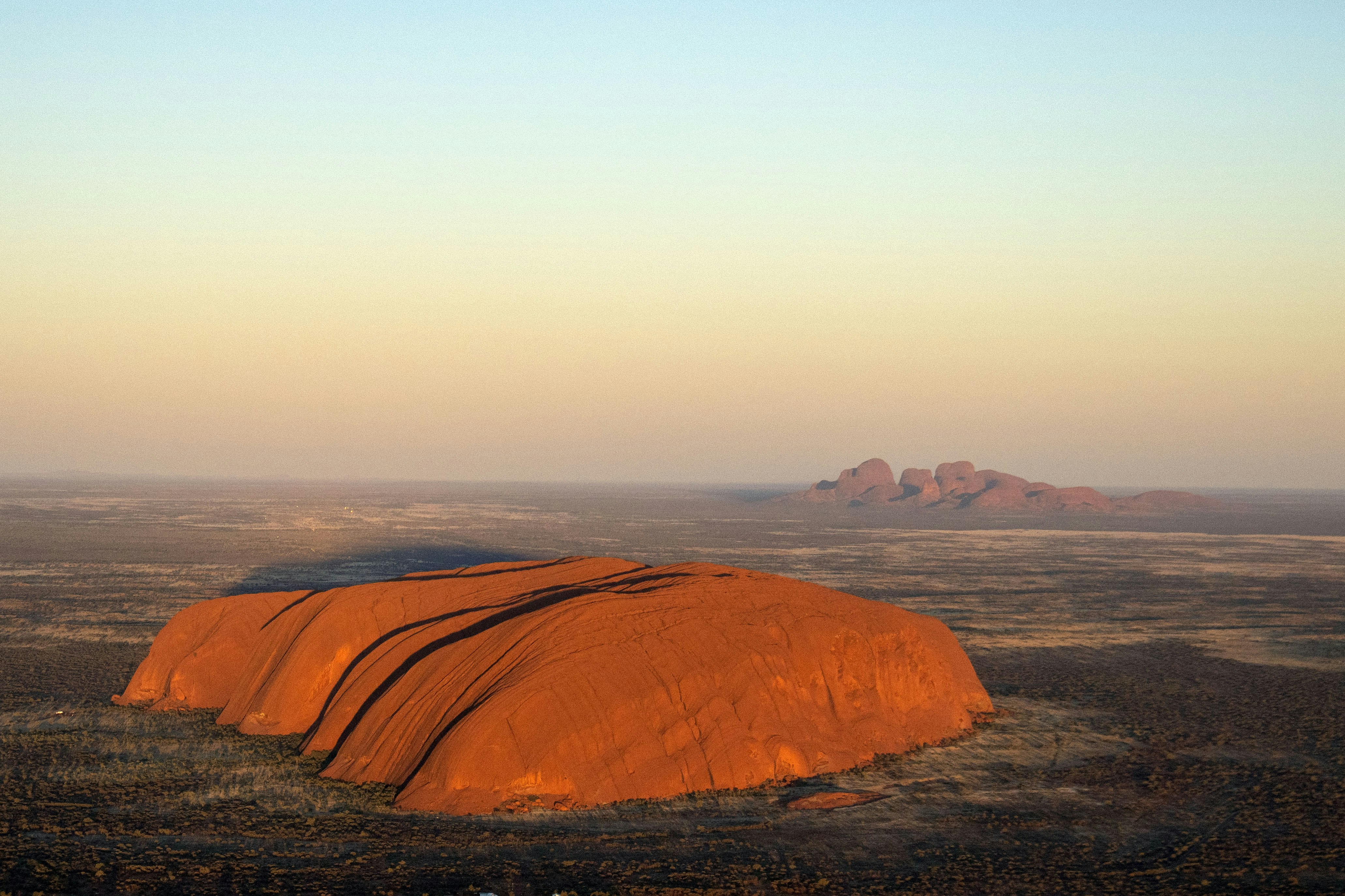 Uluru rock formation bathed in golden sunset light