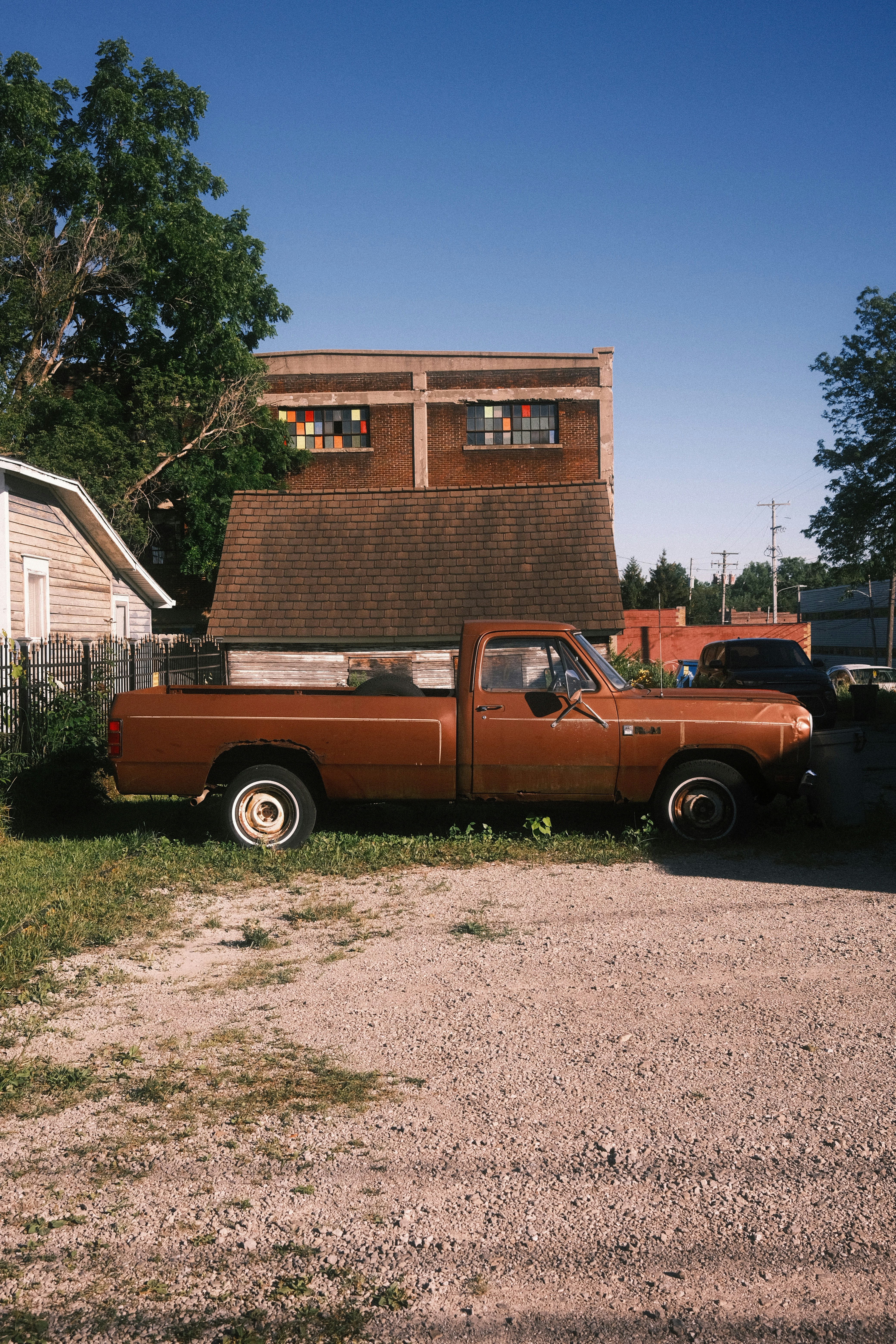 Rustic Resilience: A Timeworn Truck Amidst Urban Echoes