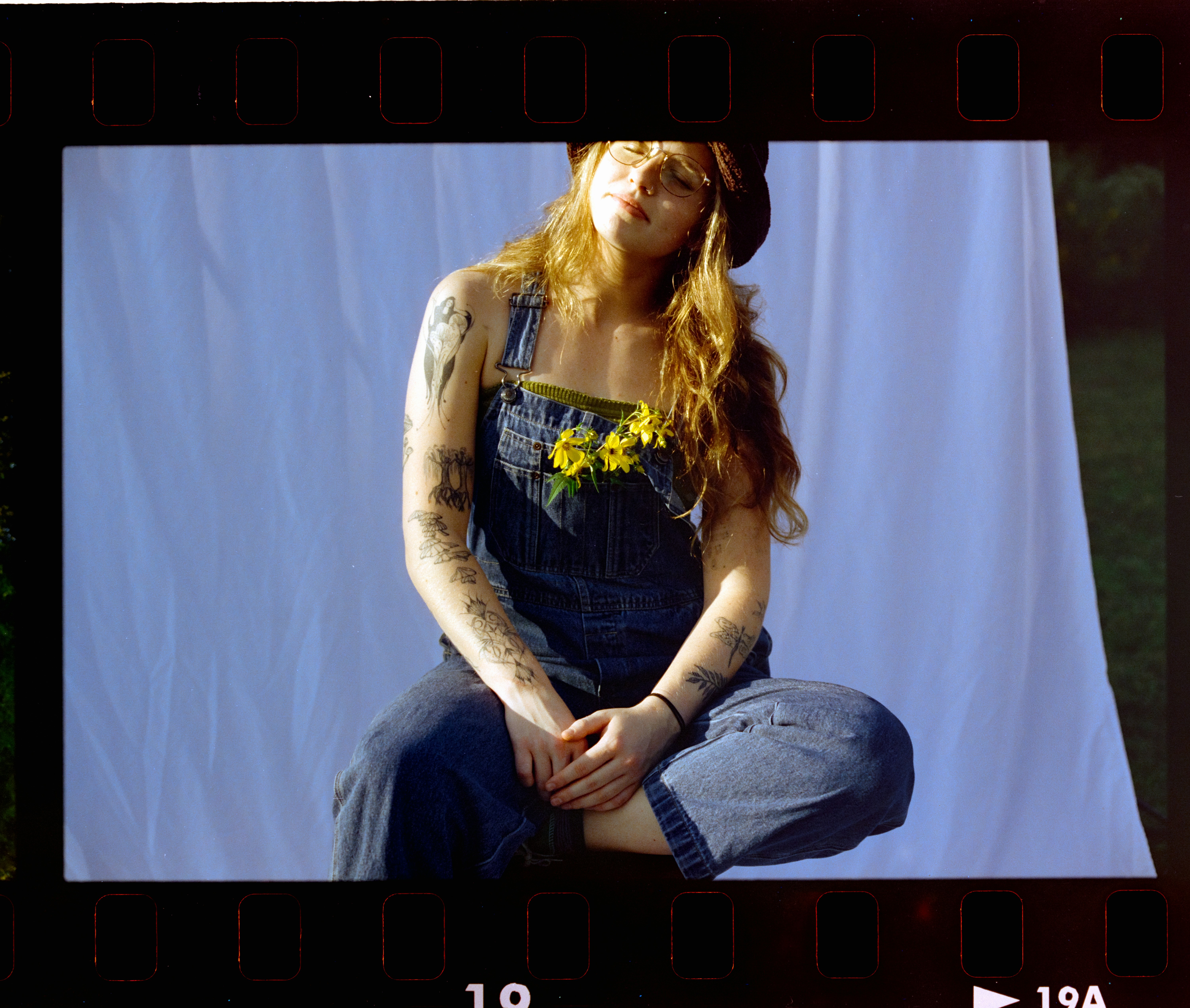 Daisy-Dusted Denim: Studio Portrait of a Tattooed Muse