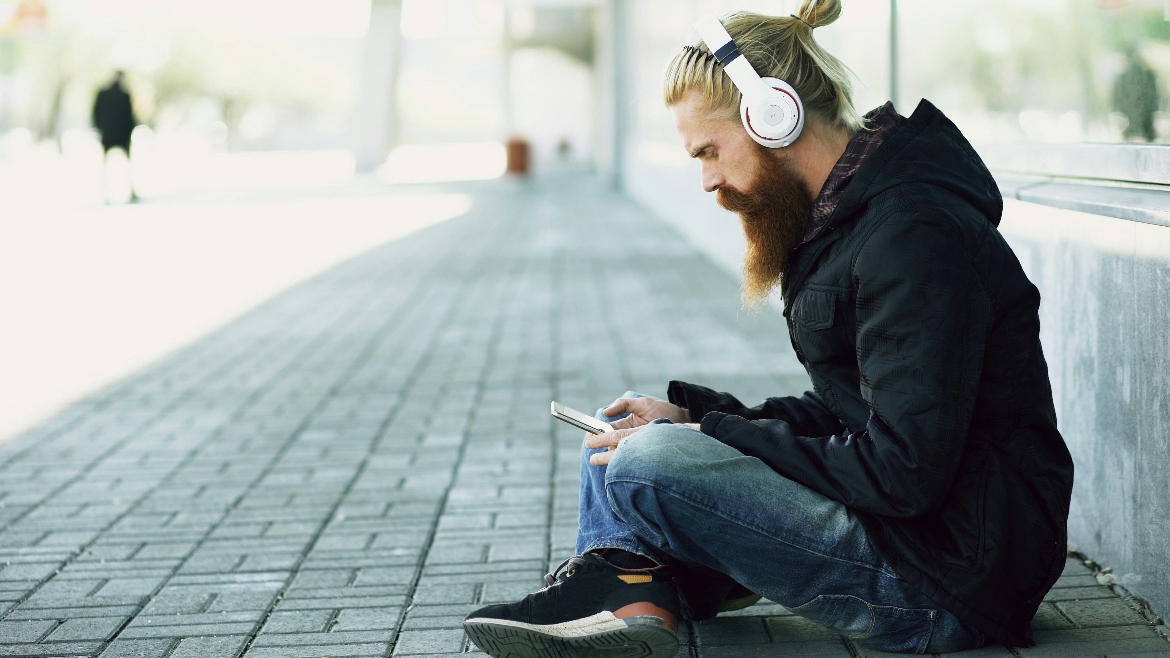 Man with headphones and beard sits listening to music photo – Free ...