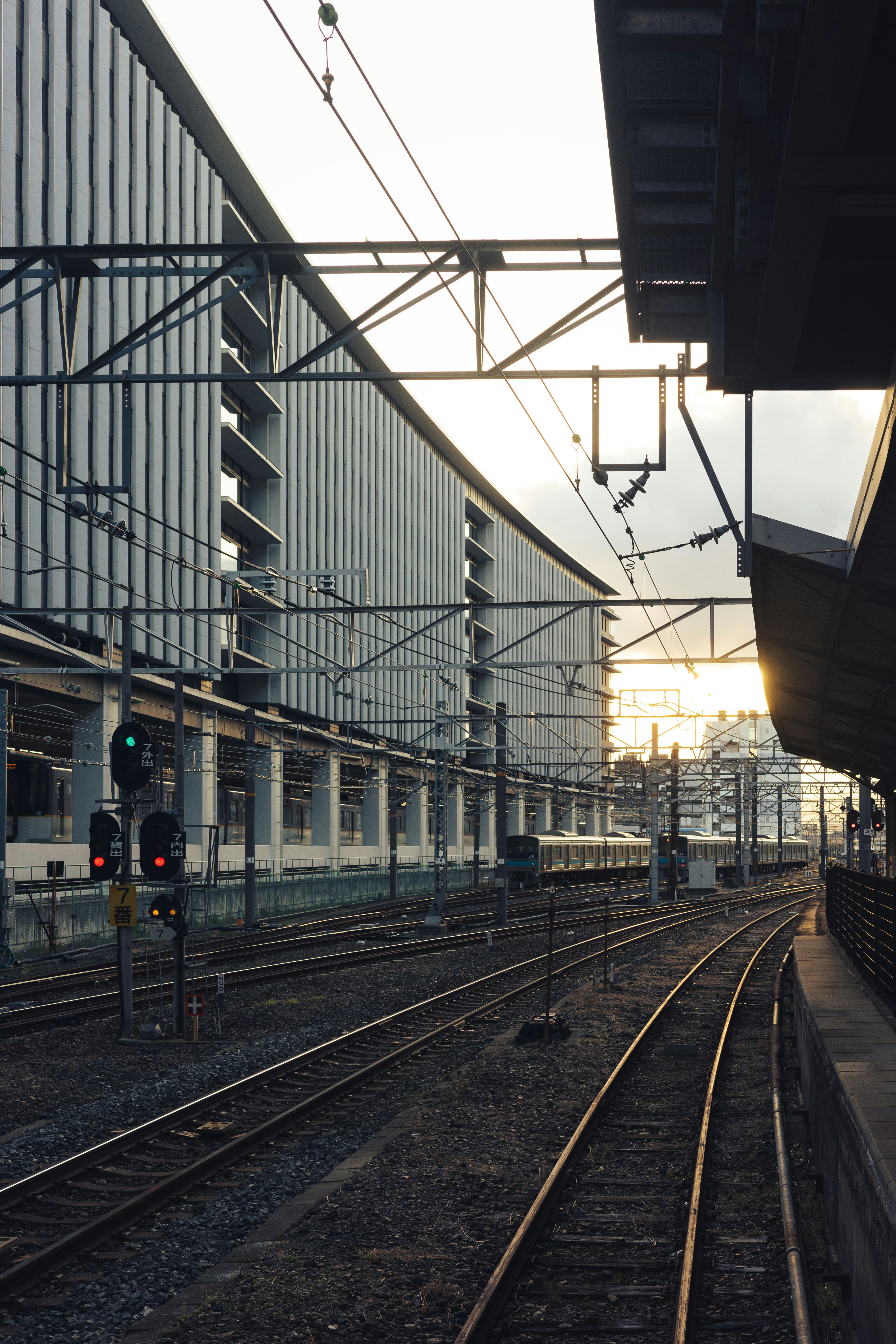 Train tracks at a station with modern buildings.