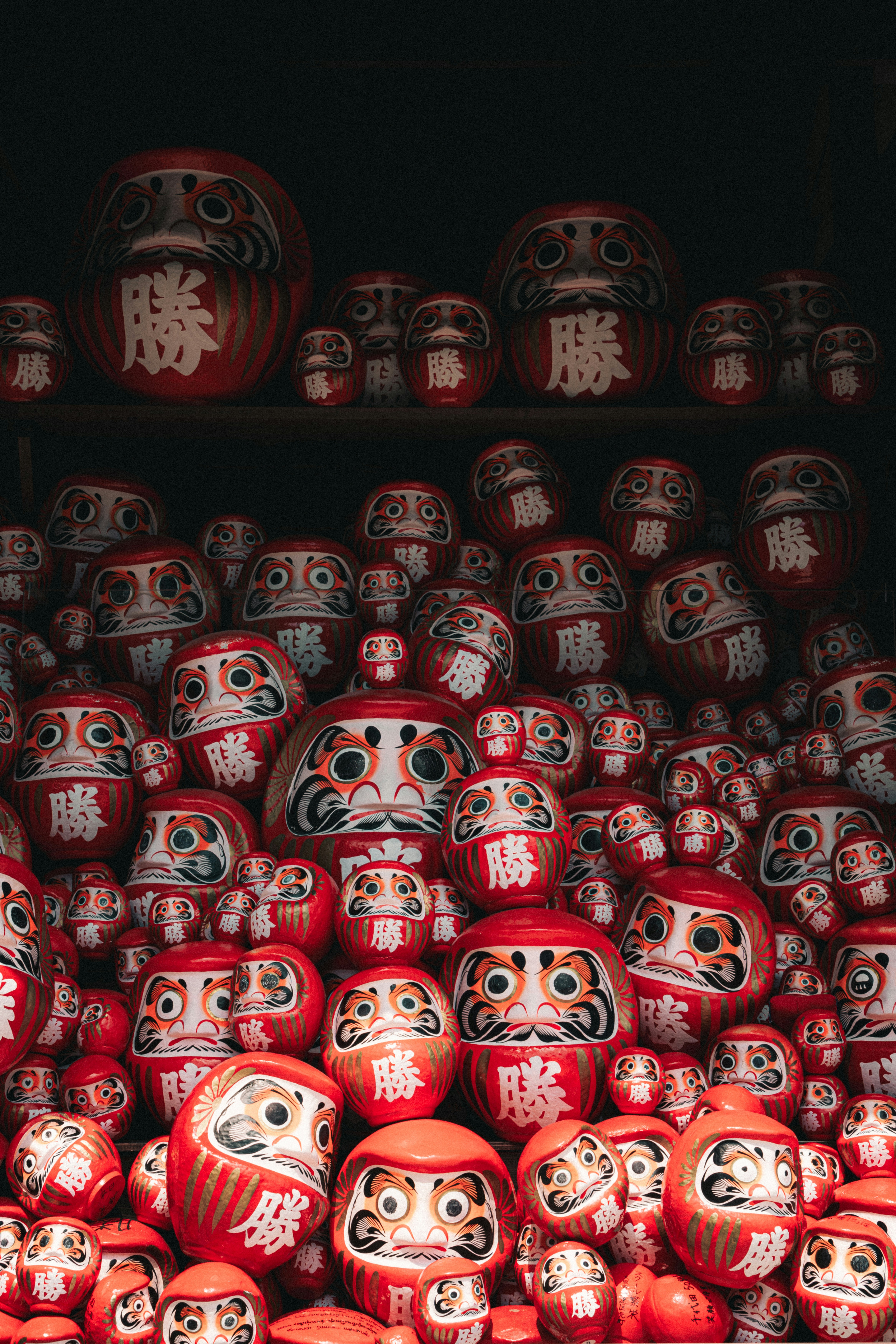 Daruma by Sun Hung | Many red and white daruma dolls are displayed.