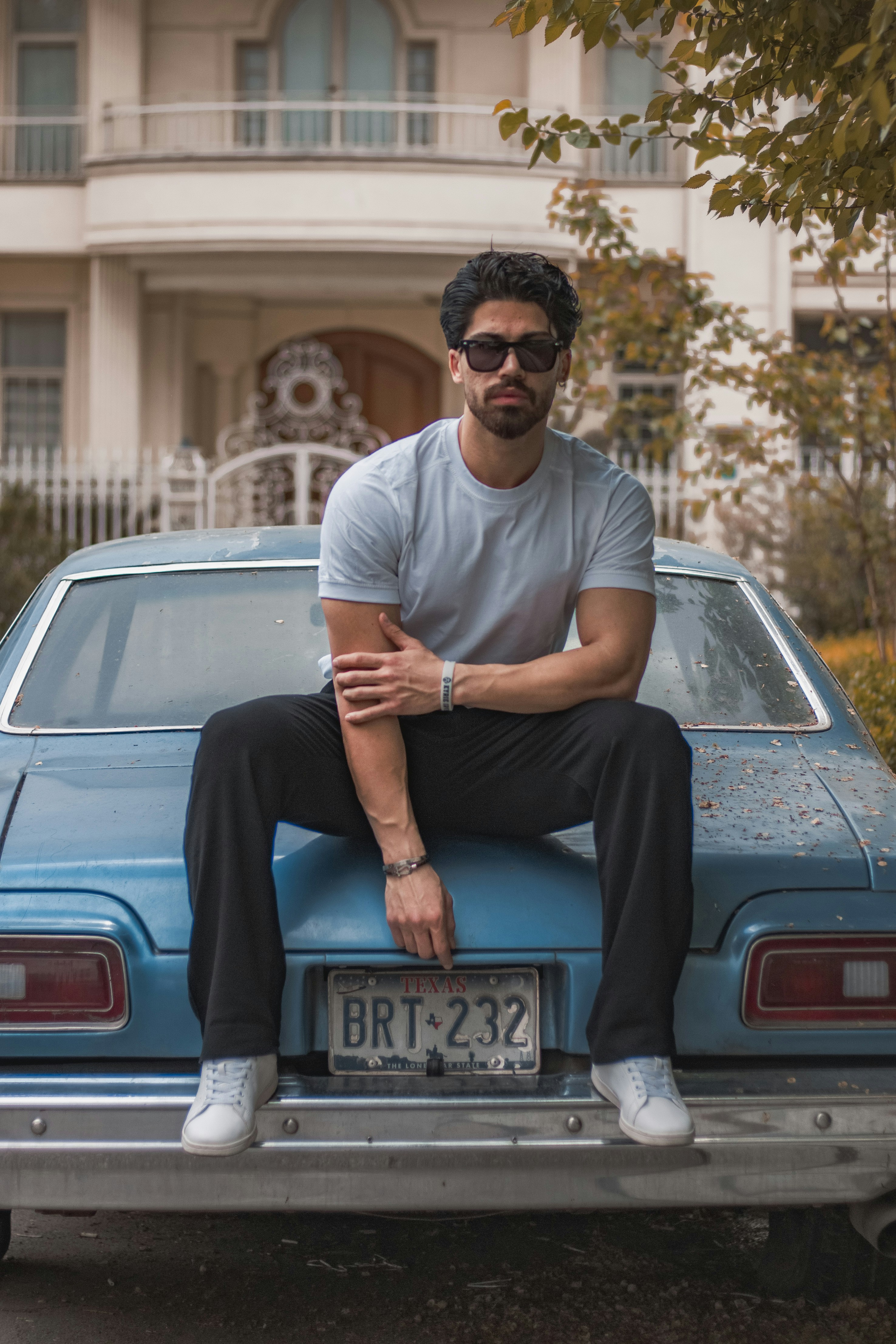 Midday Chill on Chrome: A Denim-Clad Stare on a Vintage Blue Packard