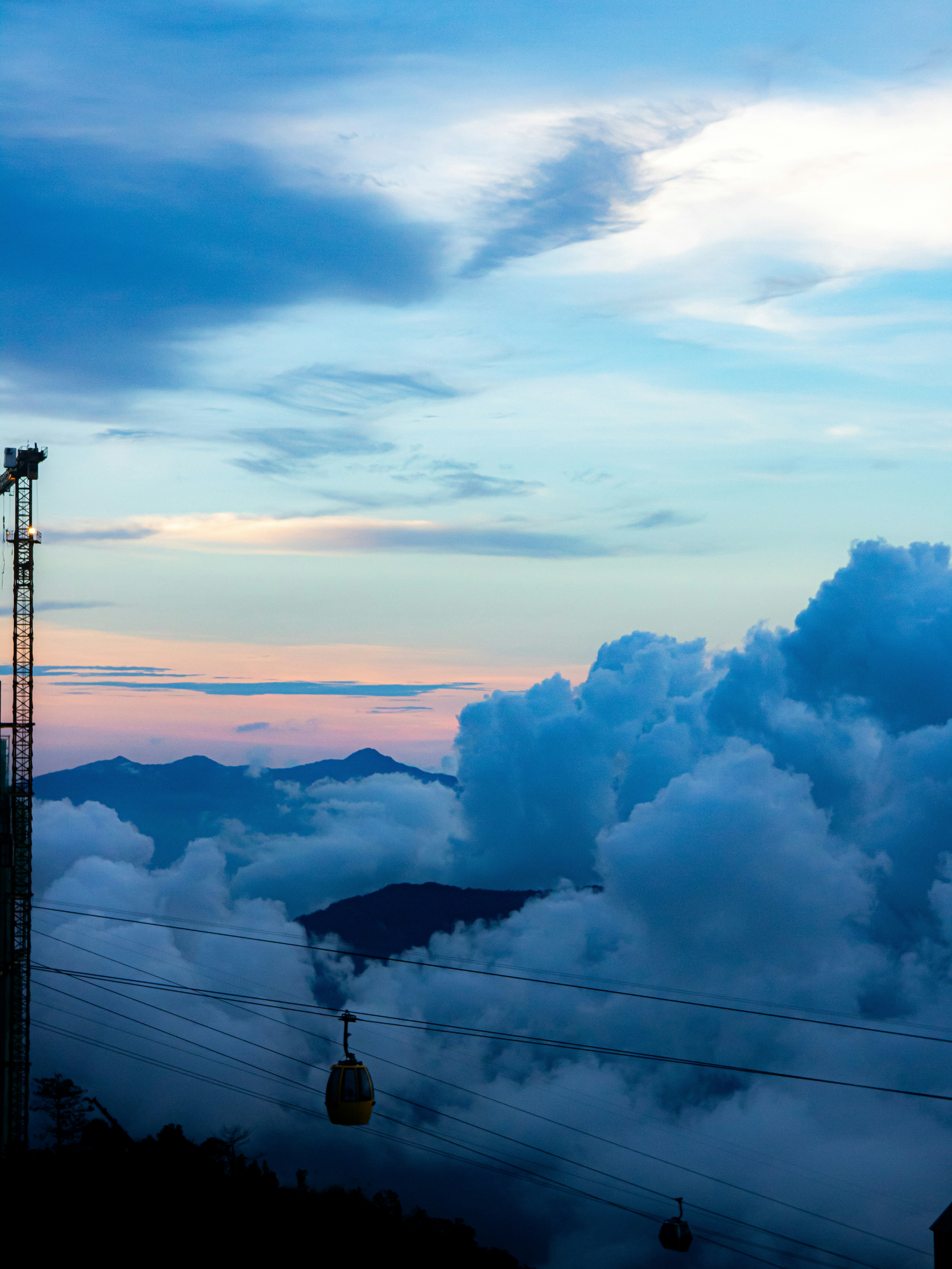 Dusk Over the Summit: Cable Lines Cut Through a Velvet Sky
