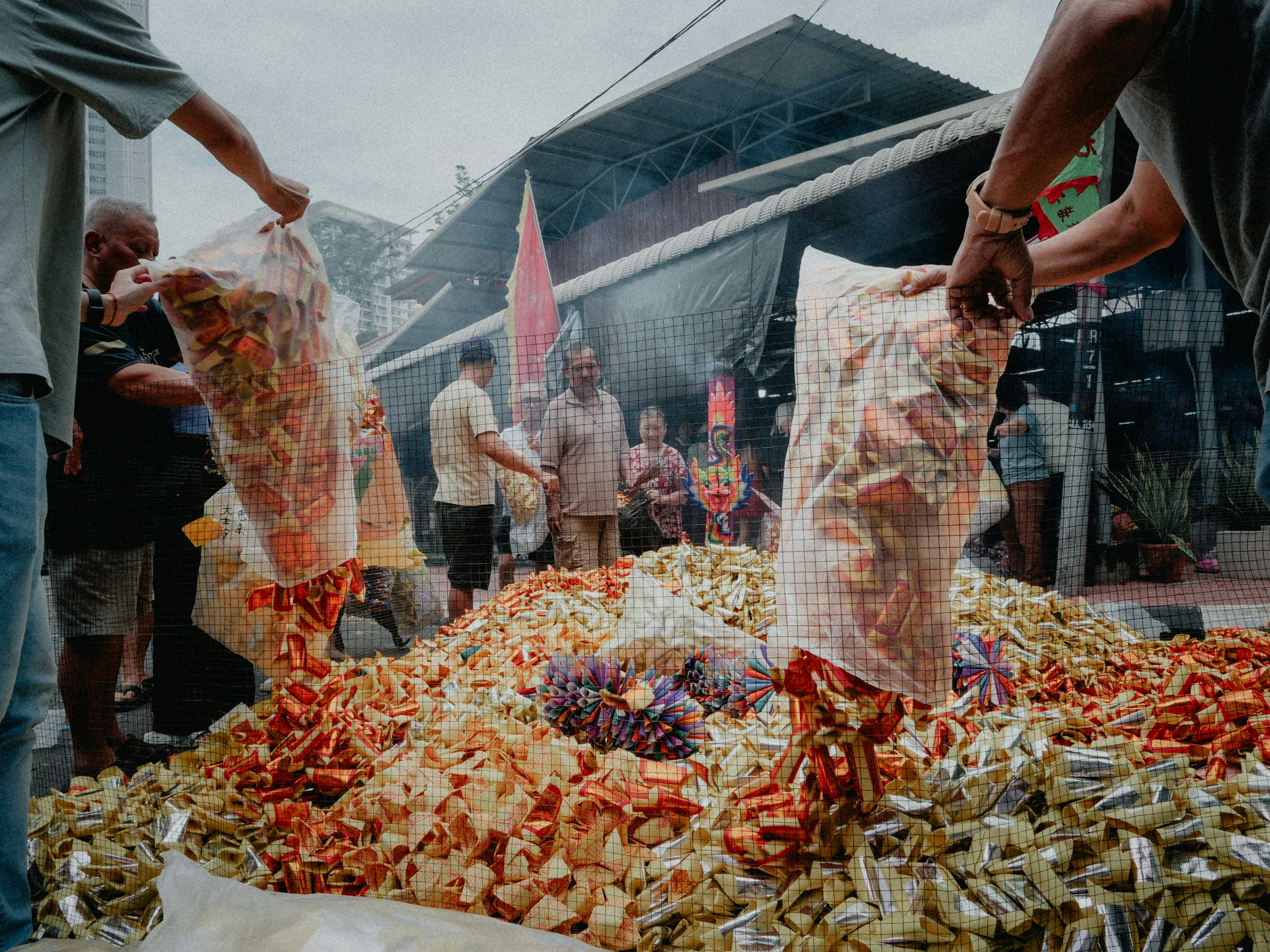 People sorting large piles of colorful vegetables and flowers. photo ...