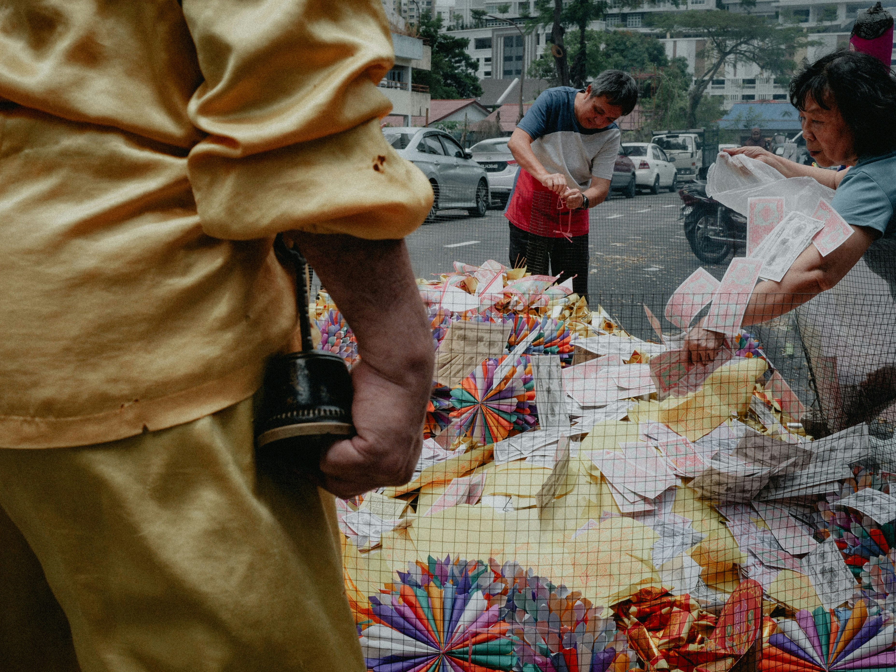 People arranging offerings on a street