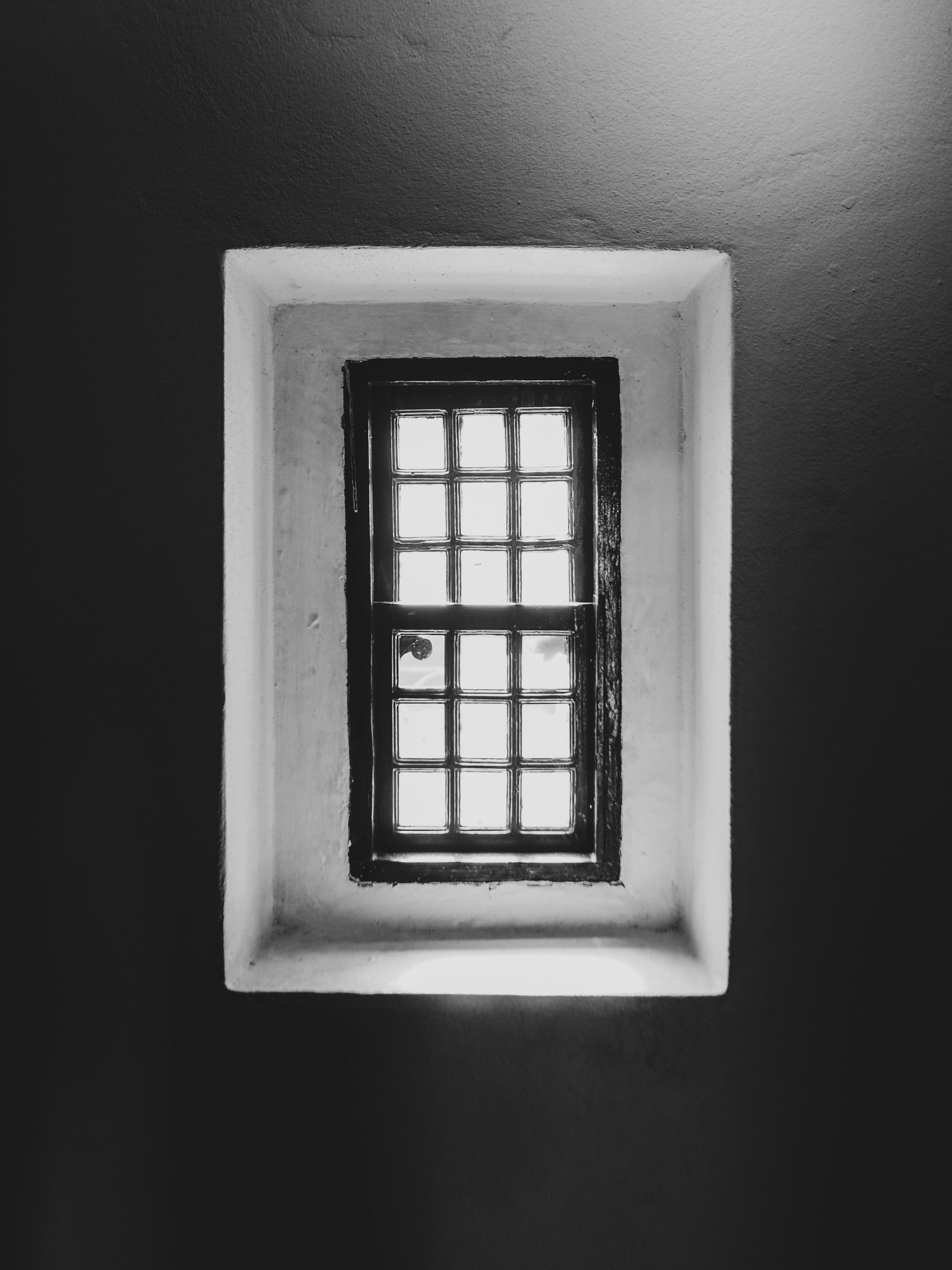 A dark, square window with many panes.