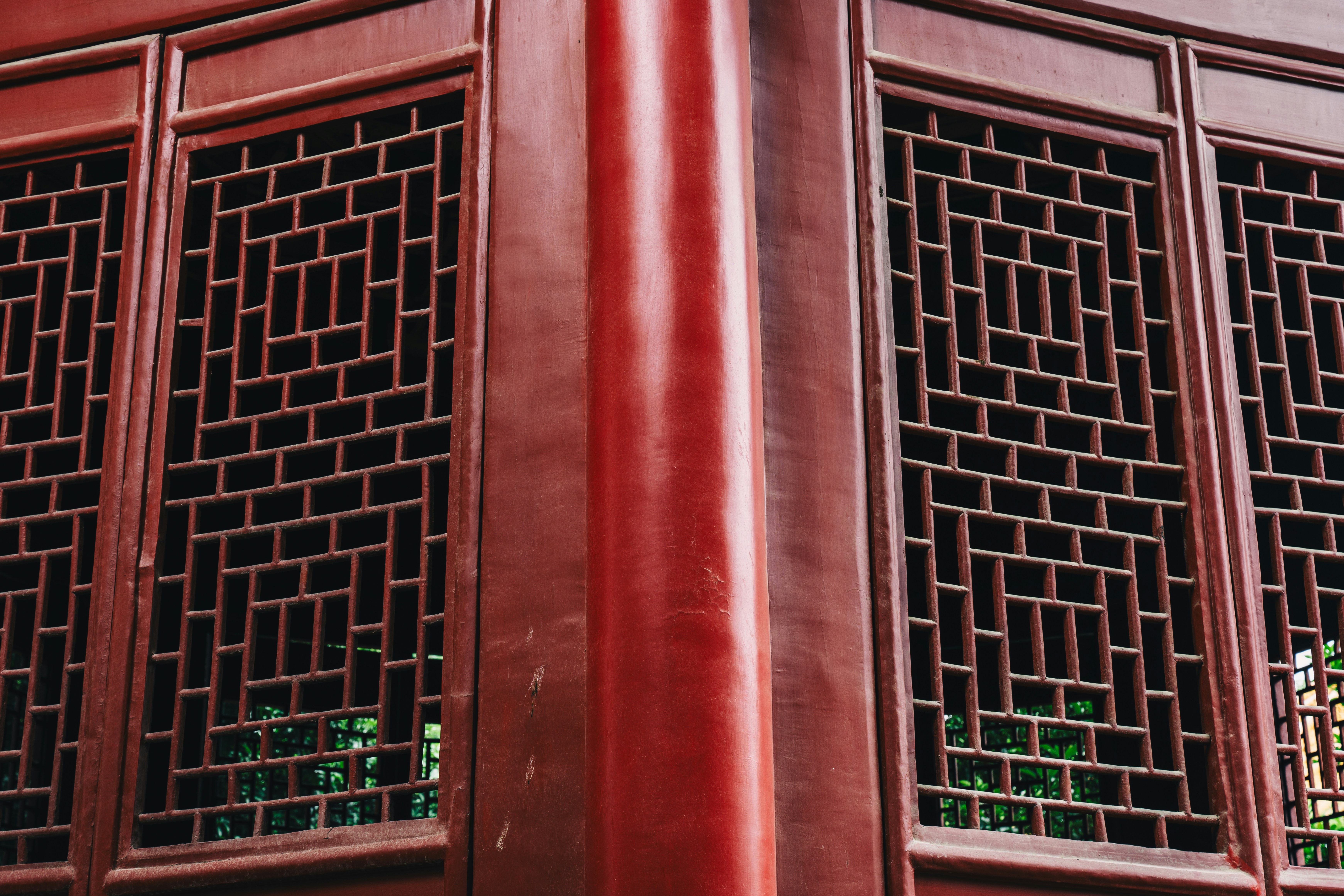 Traditional chinese architecture with red wooden lattice windows.