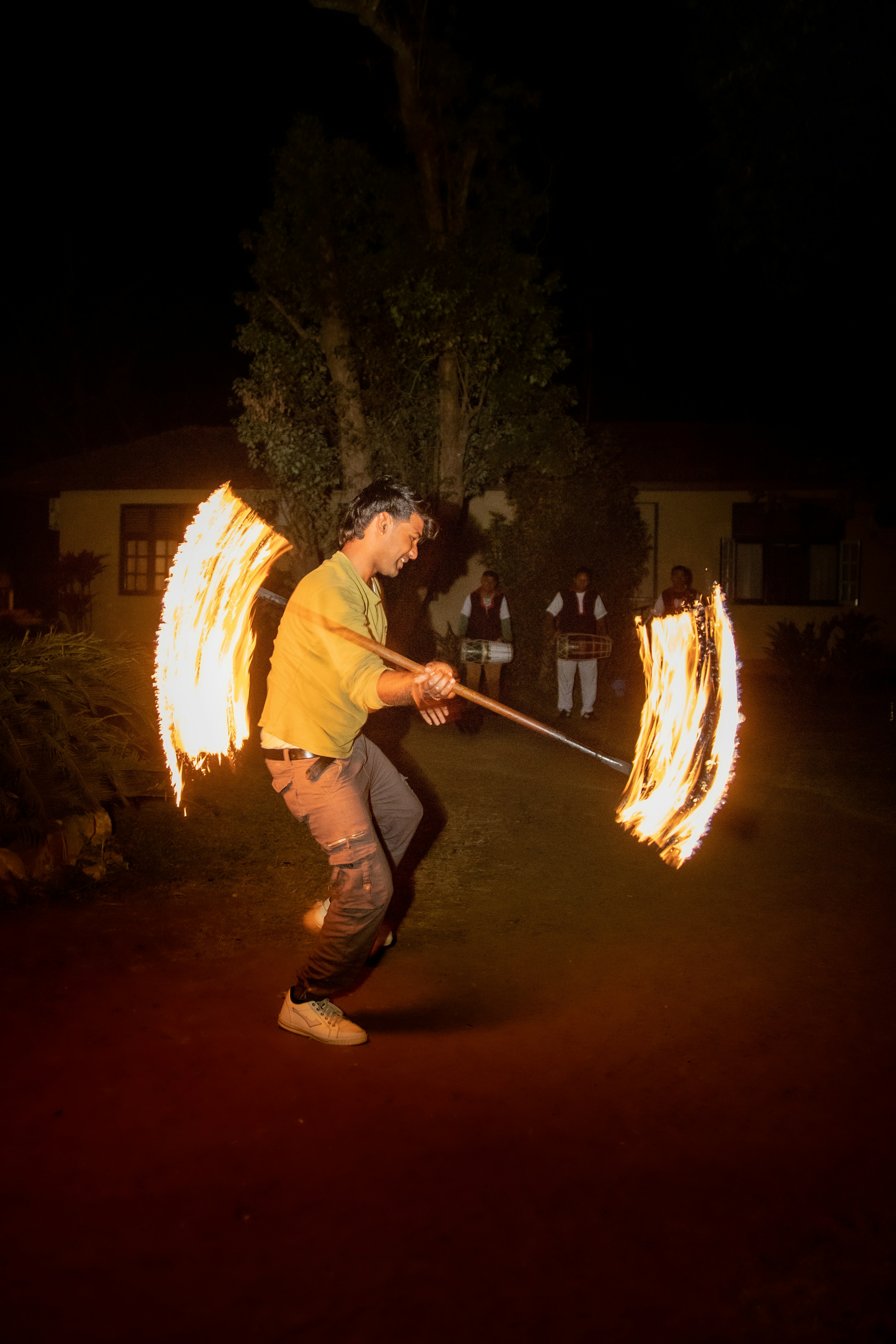 Man performs fire dancing with flaming poi sticks at night. photo ...
