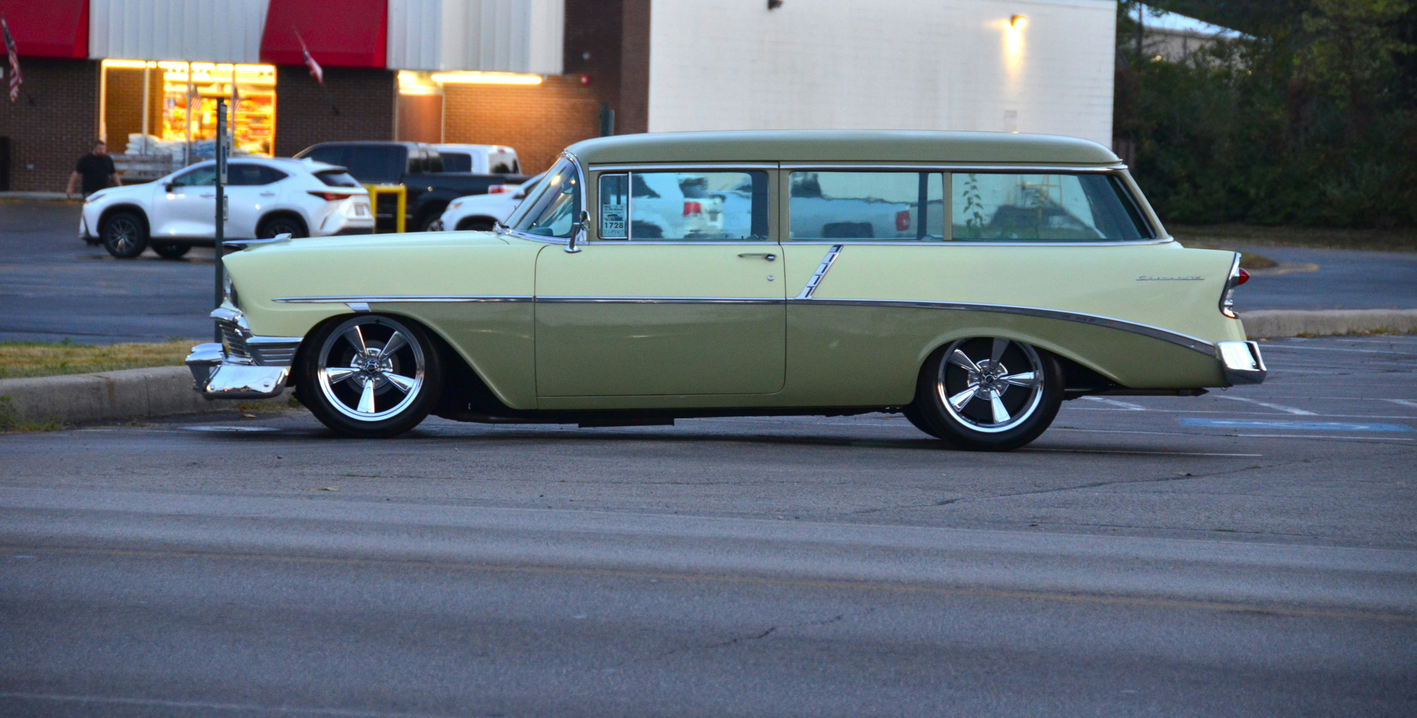 Mint-green 1957 Bel Air Resting in a Quiet Parking Lot Under Afternoon Light