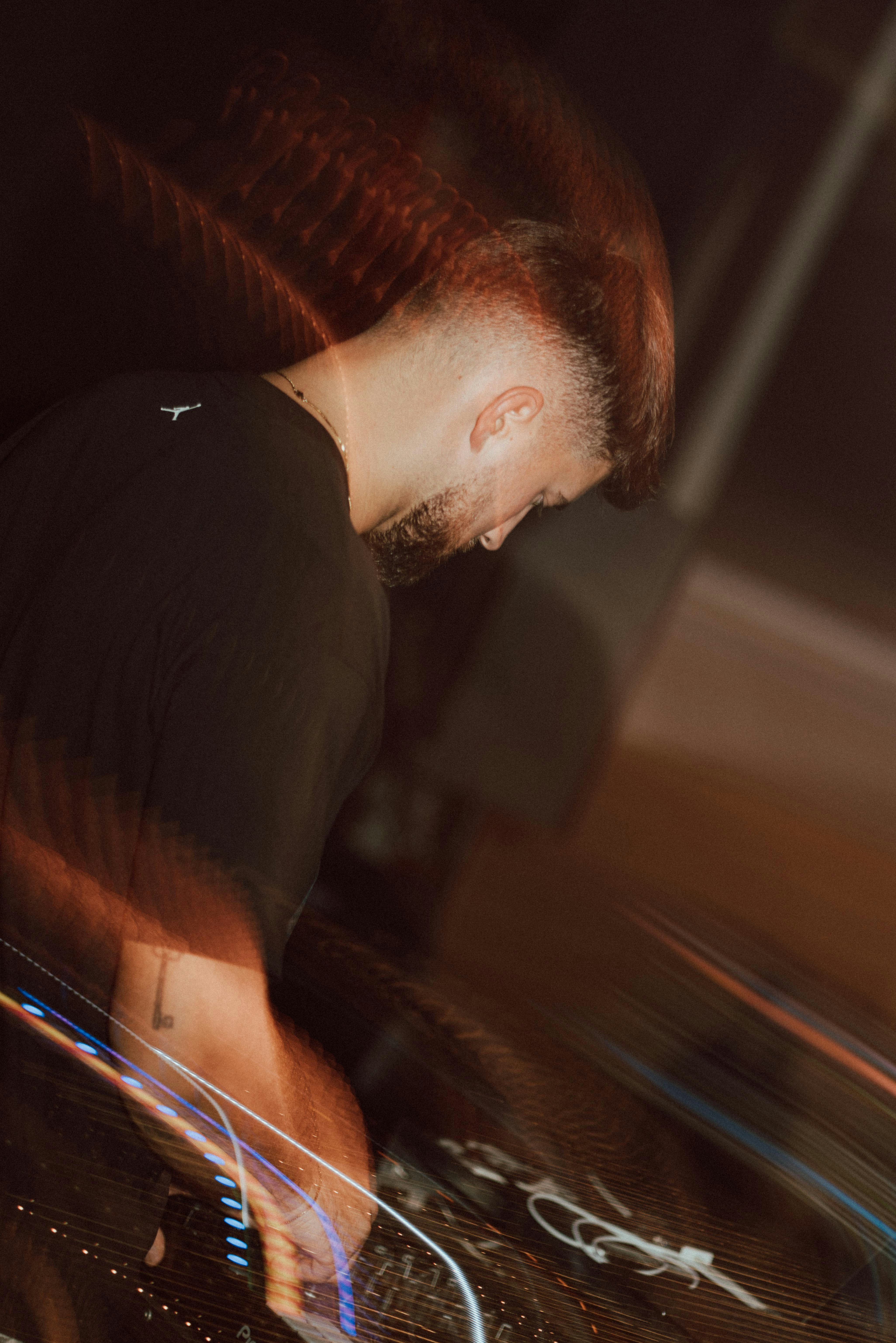 Man with blurred motion effect at a dj booth
