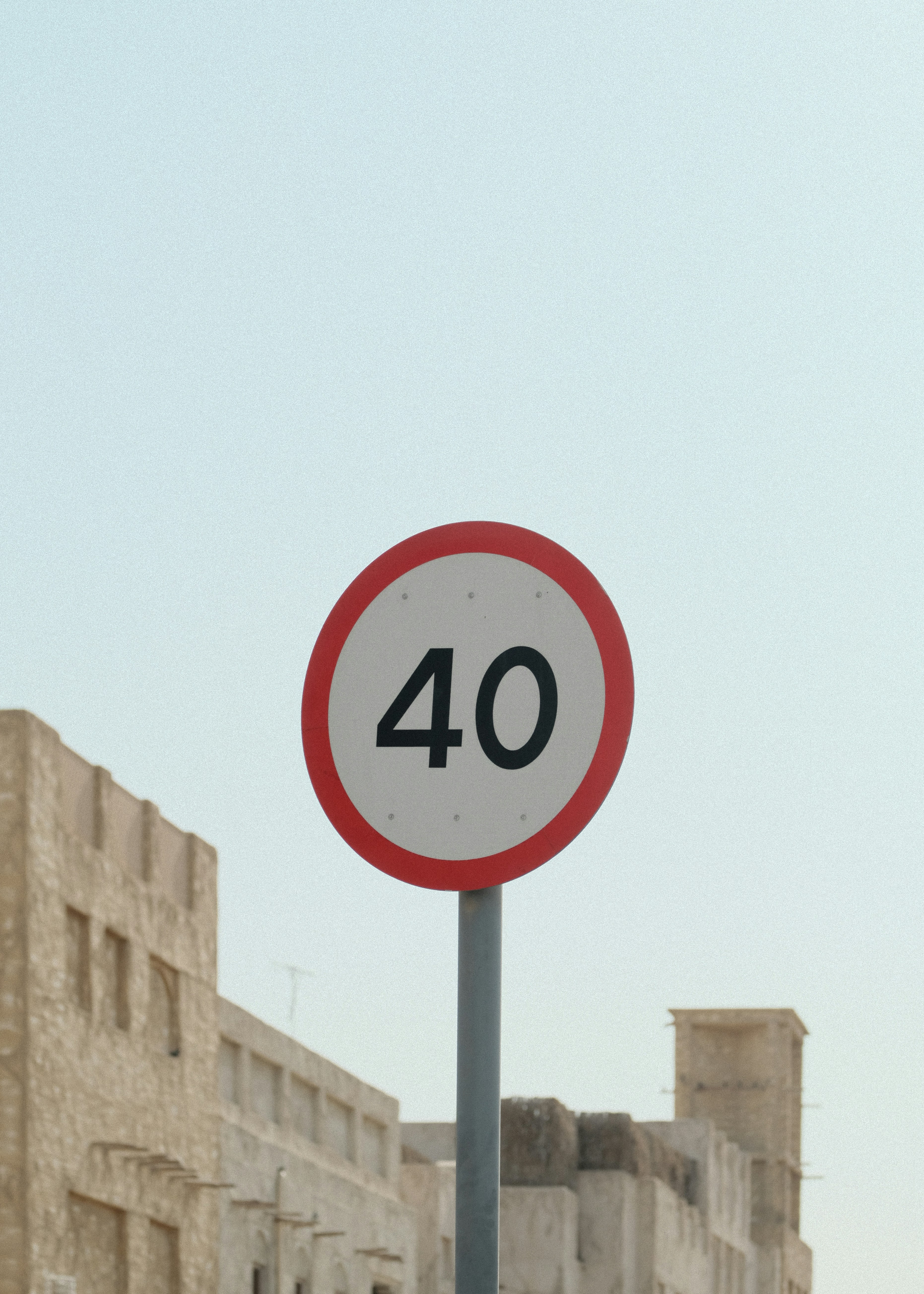 Speed Limit Sign Amidst Urban Decay