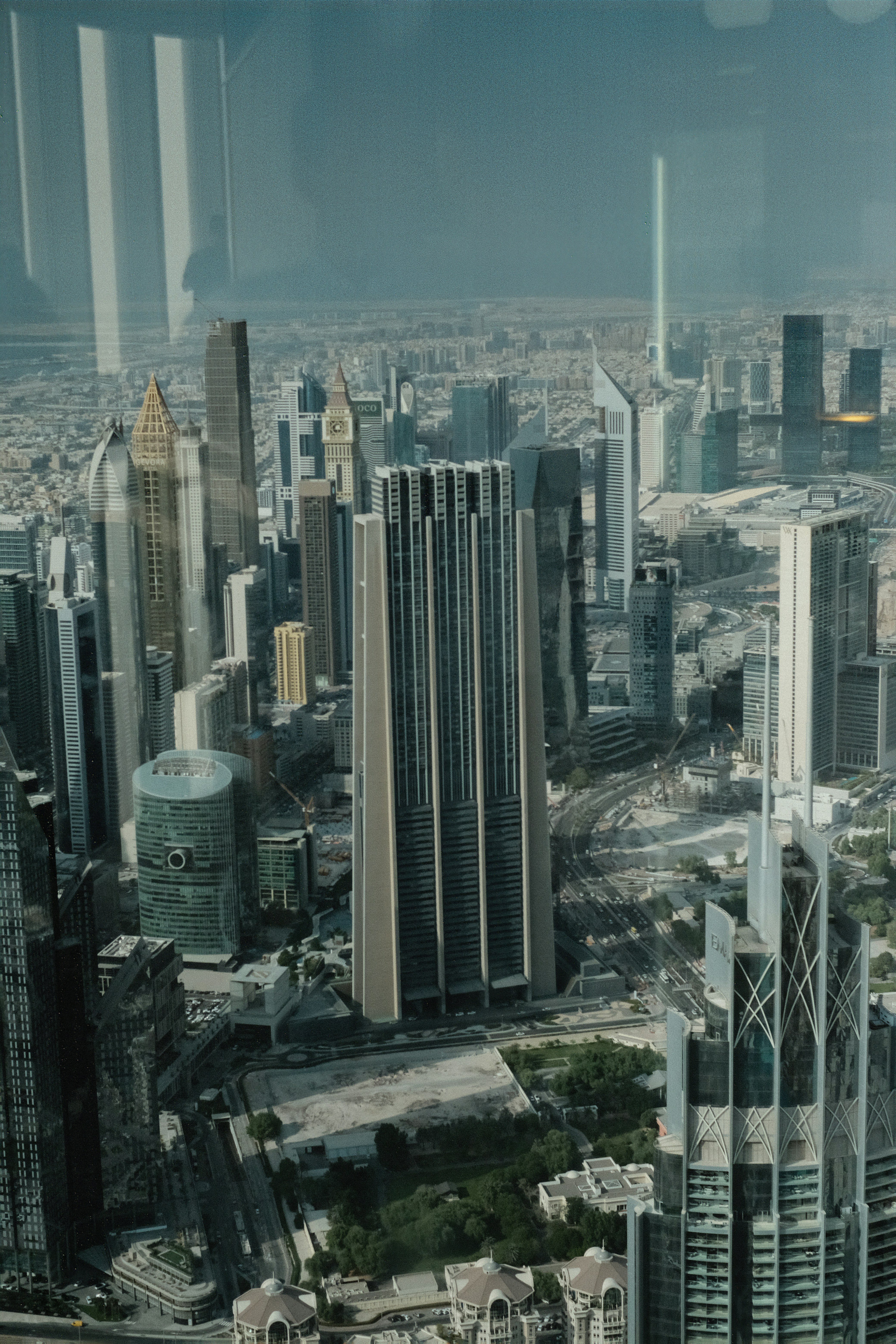 Aerial view of a bustling cityscape featuring a mix of modern skyscrapers and intricate urban layouts. The image showcases the architectural diversity and complexity of the city.