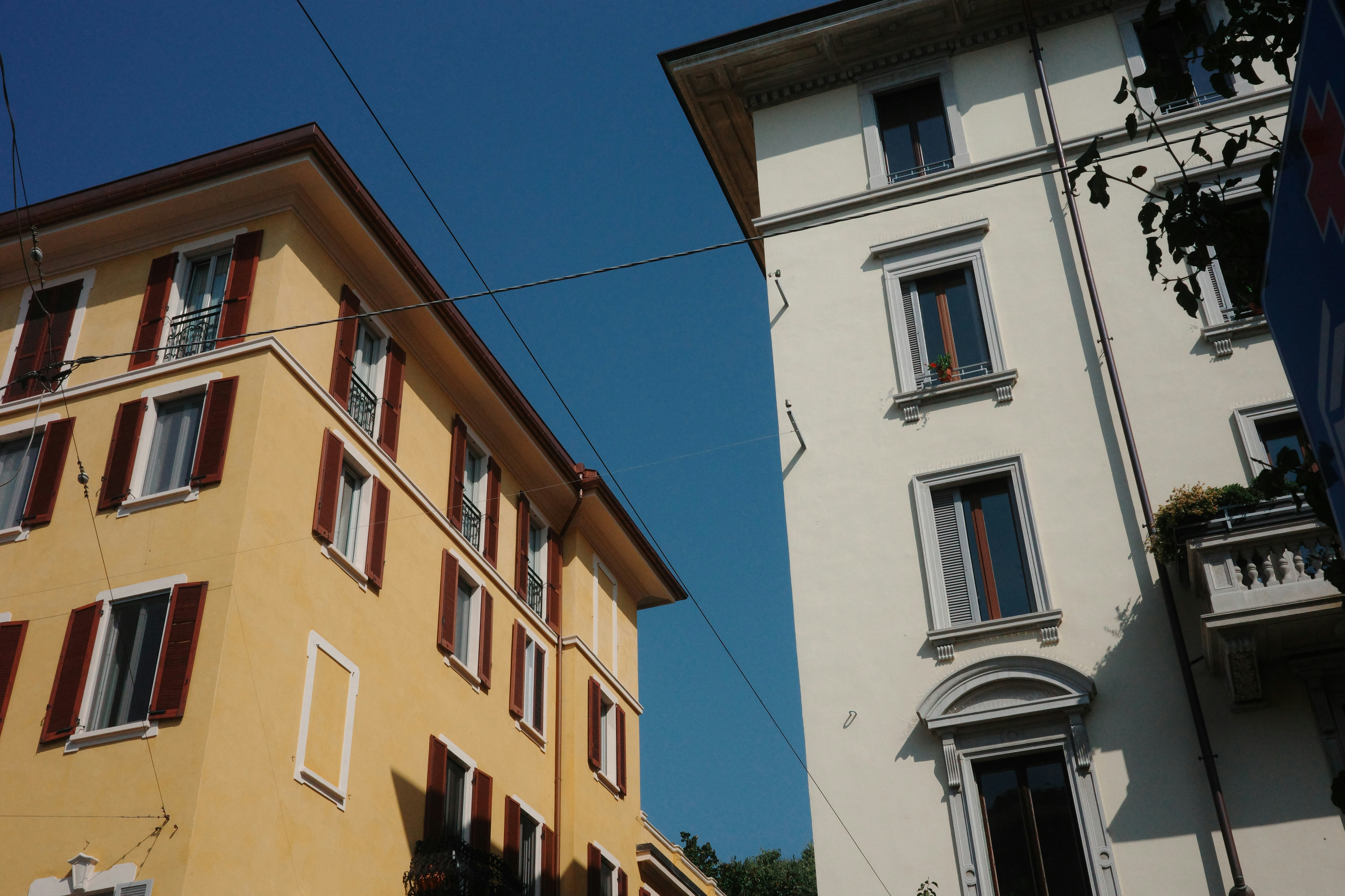 Two buildings against a clear blue sky.