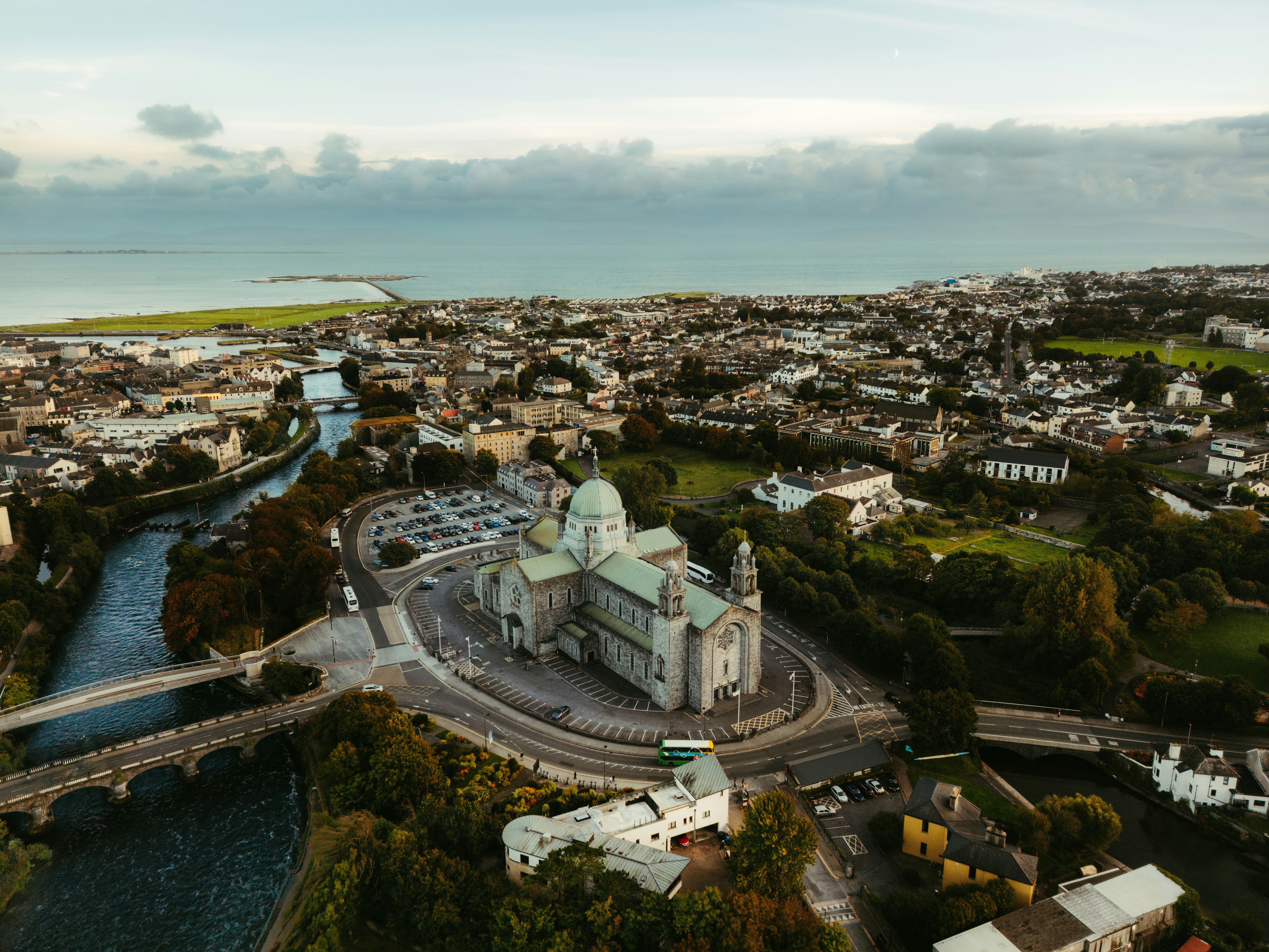 Aerial View of the Green-Domed Cathedral Amid a Coastal City
