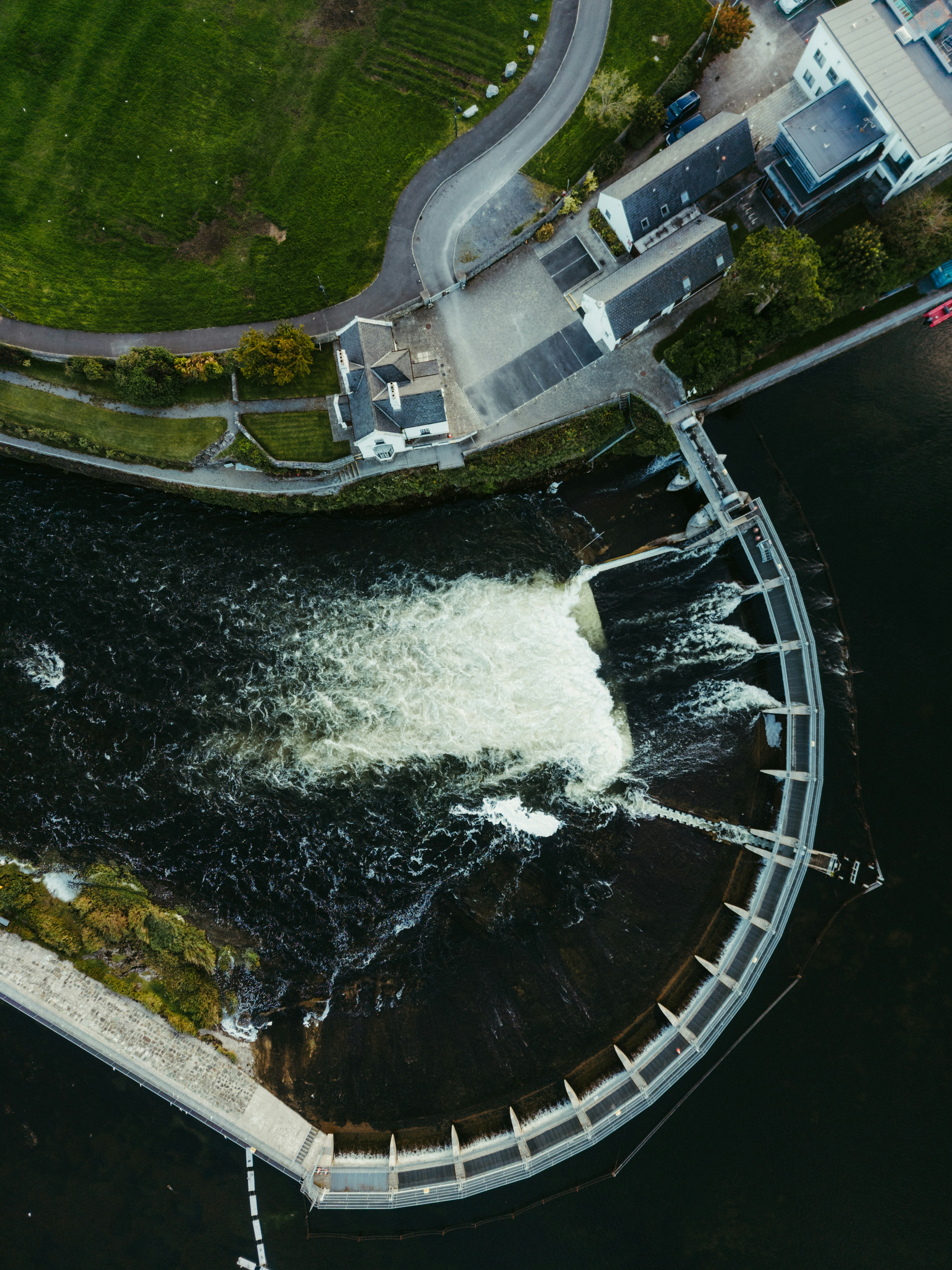 Aerial view of a dam with water flowing over it.