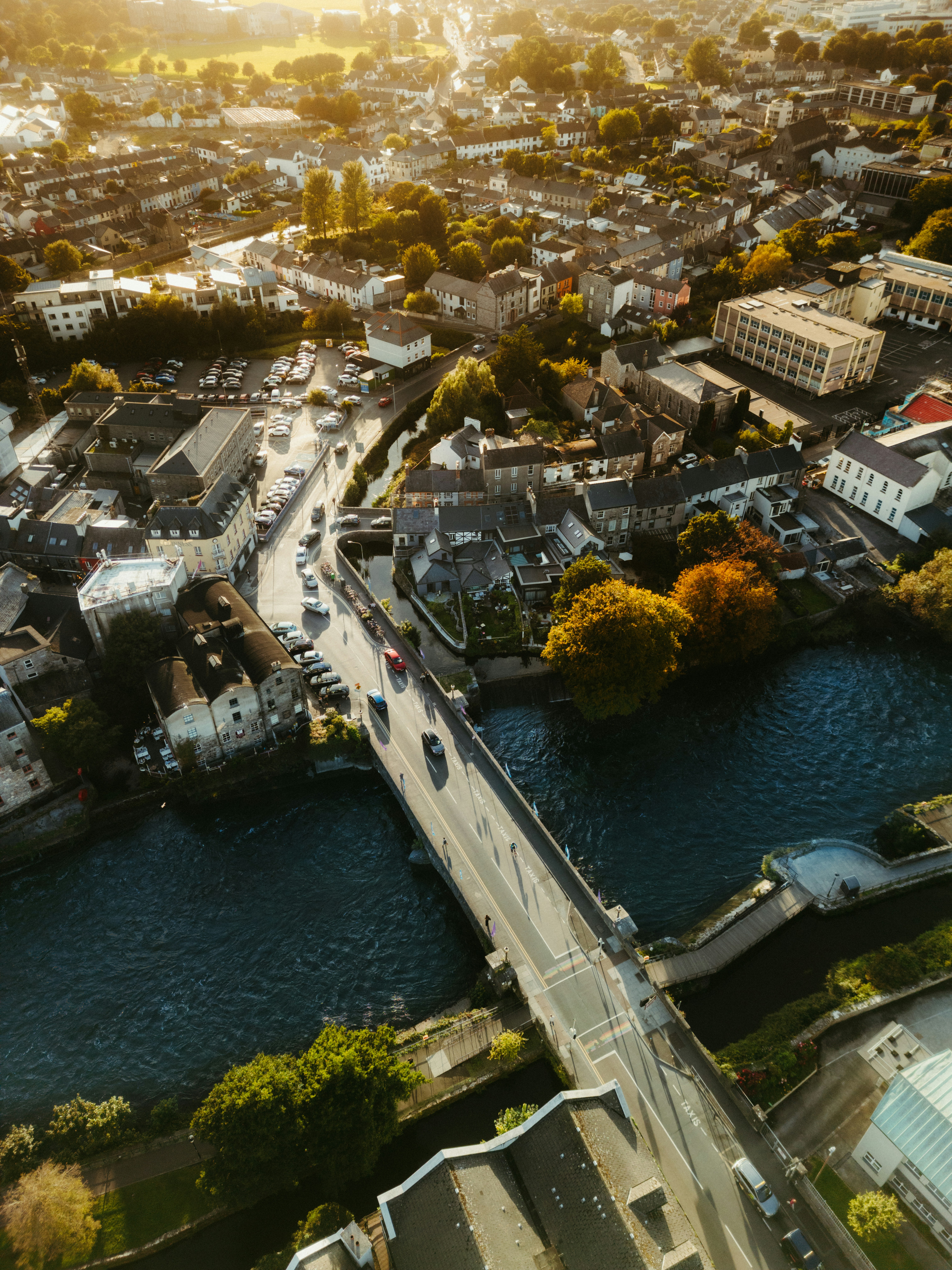 Riverside Overpass in Warm Light: A Bird's-eye View of a Waterfront Town