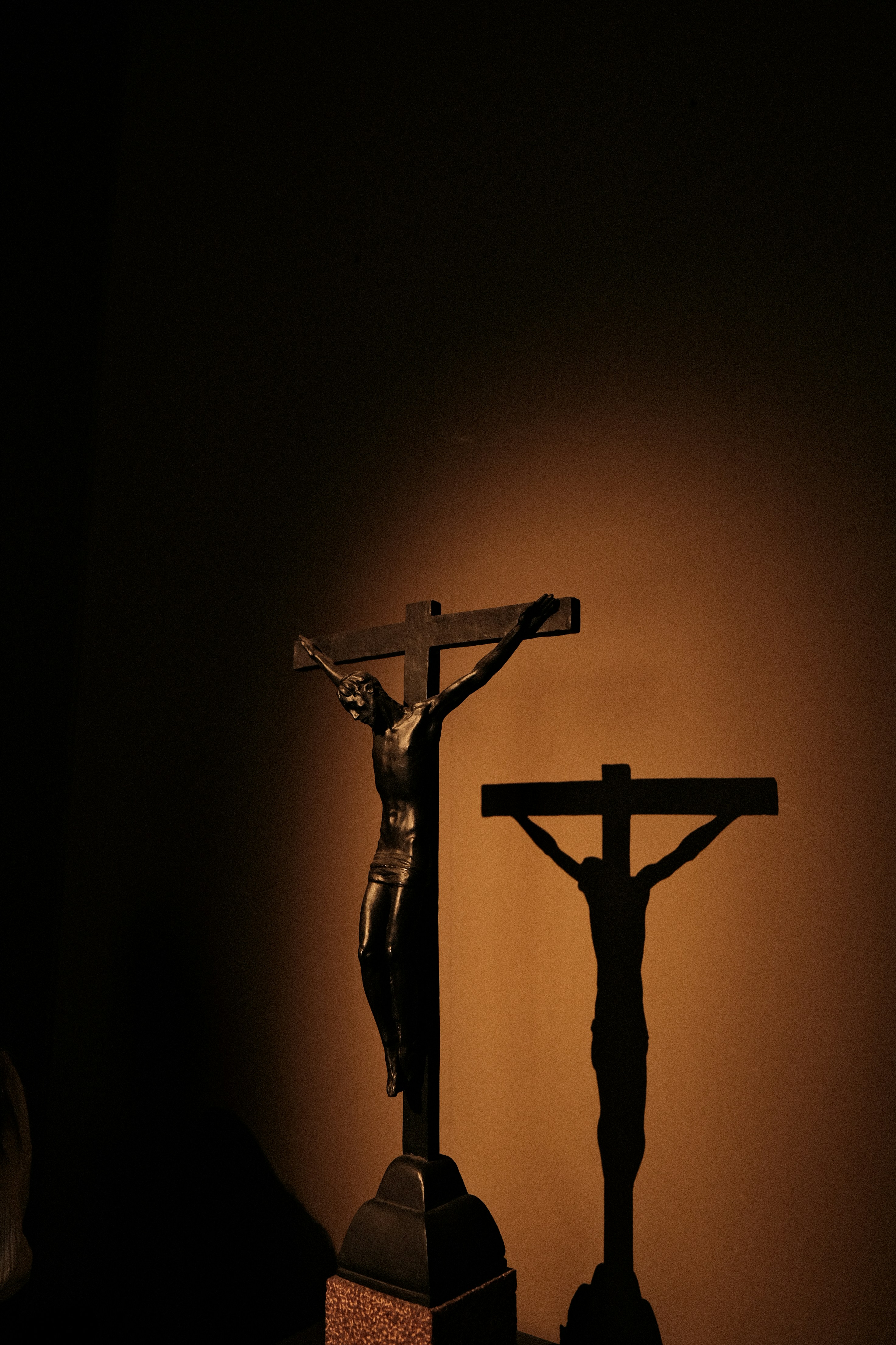 Crucifix with shadow against a dark background