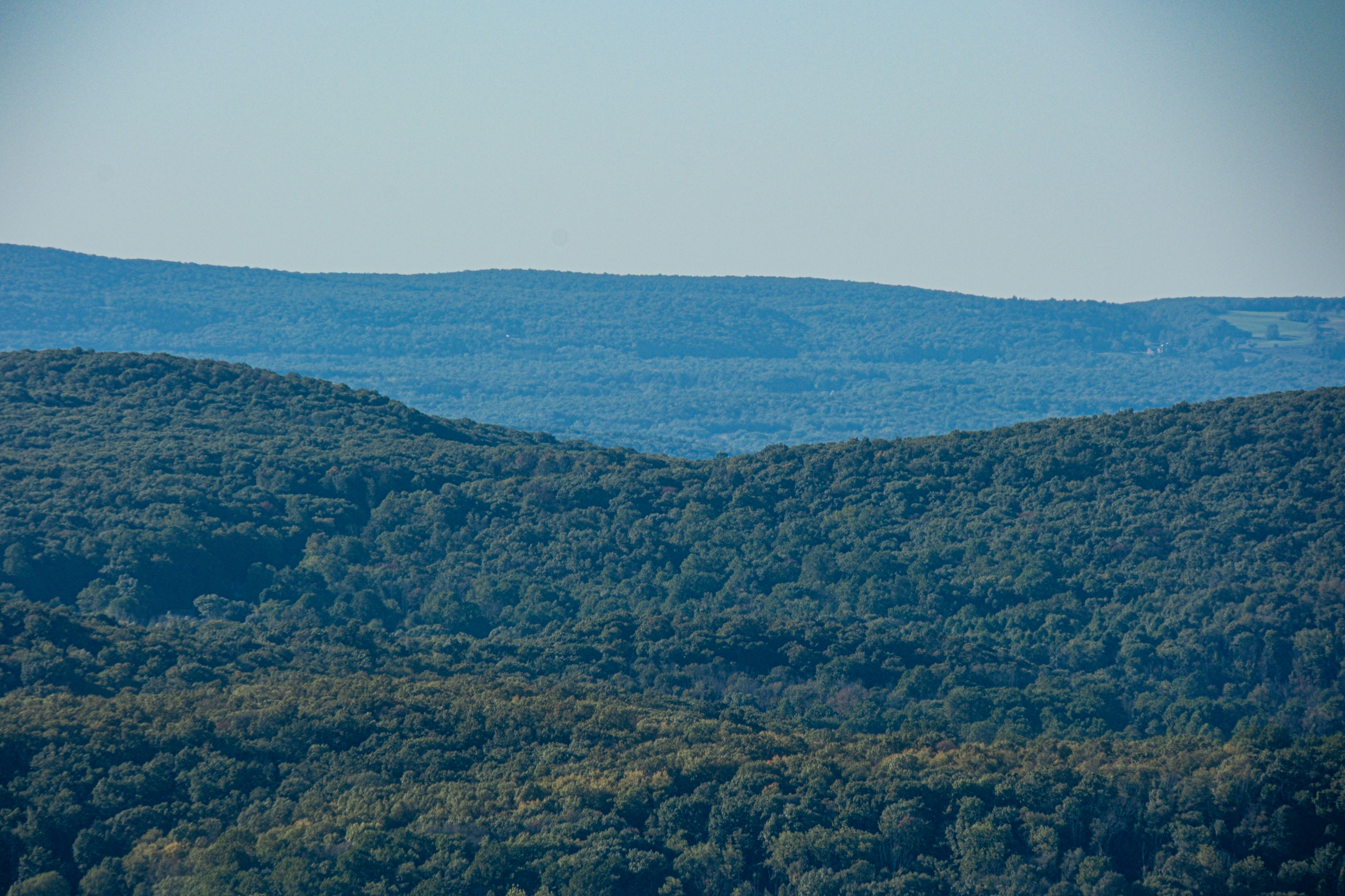 view from the top of stairway to heaven trail | Rolling green hills under a clear blue sky