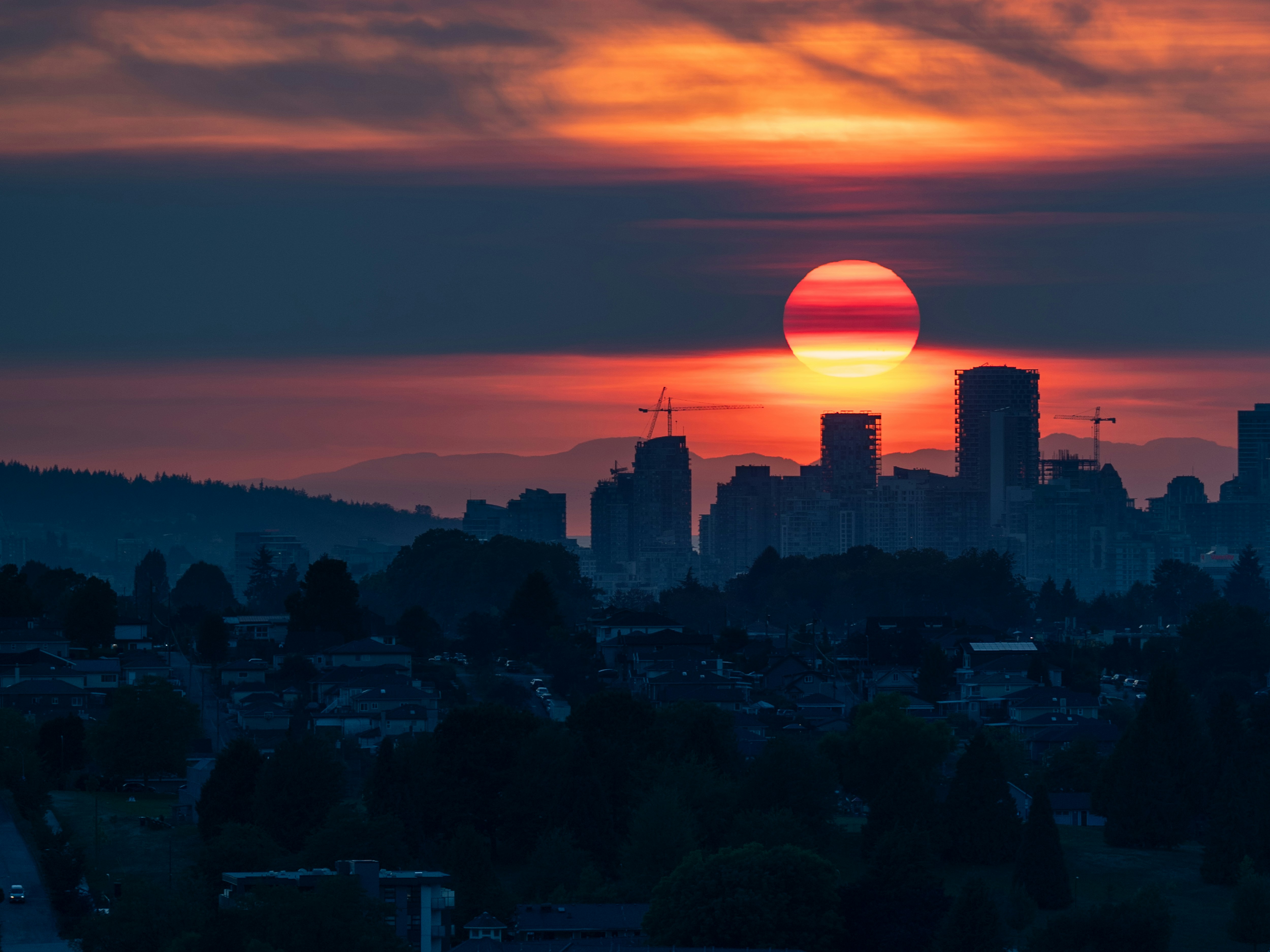 Urban Silhouette Against a Fiery Horizon