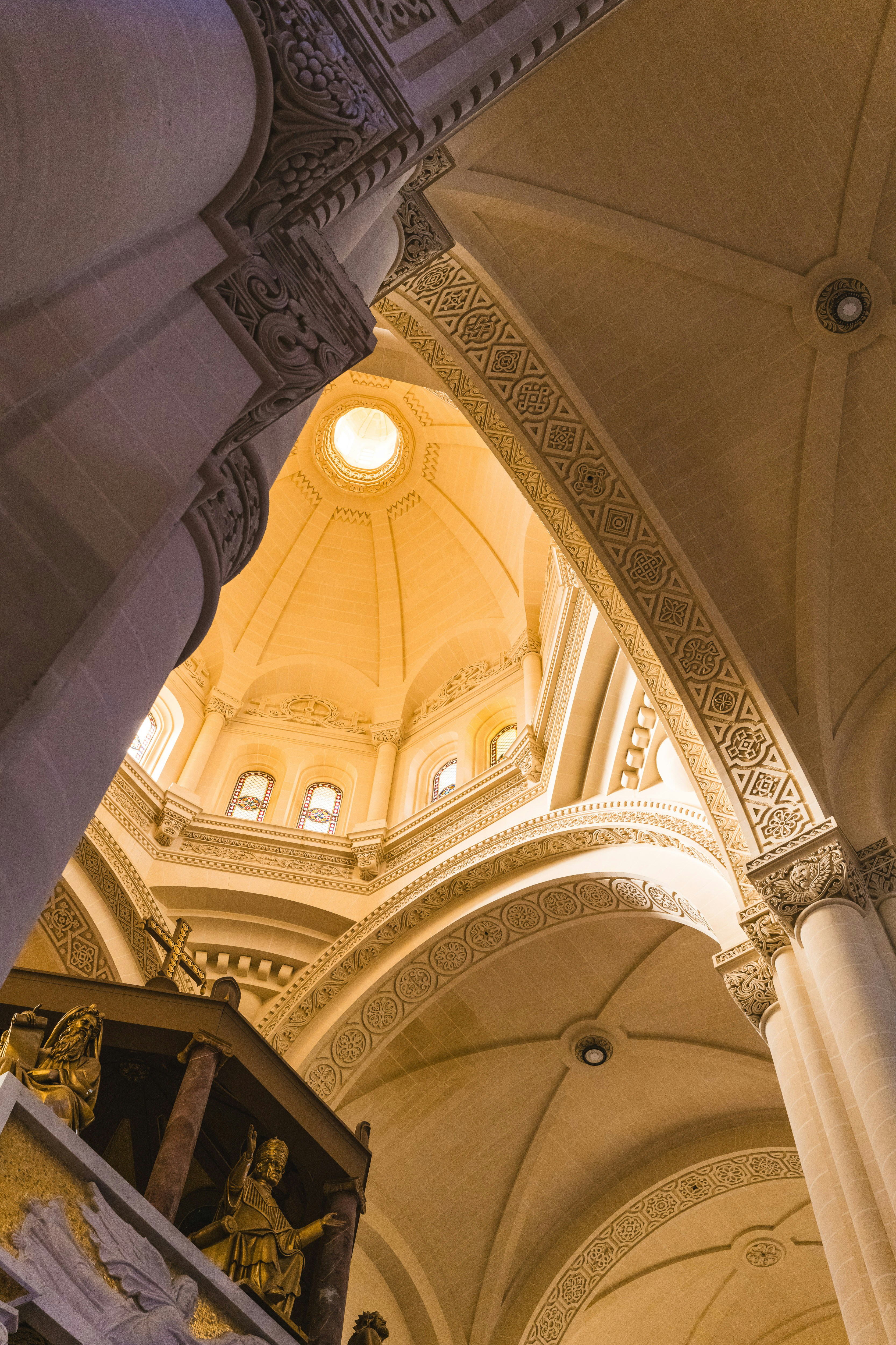 Interior view of a grand dome with ornate architecture.